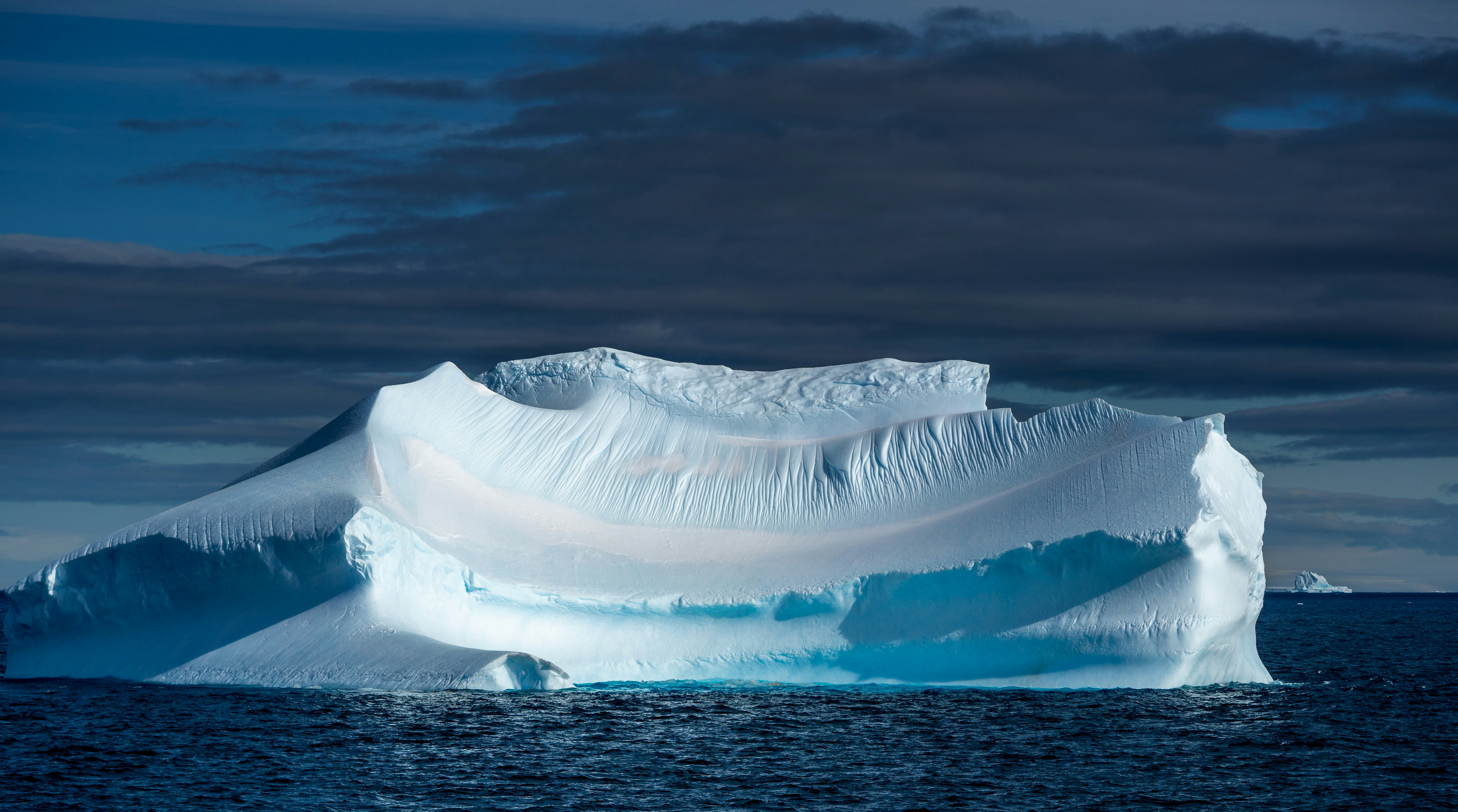 A large iceberg floating in the middle of the ocean photo – Free Fish ...