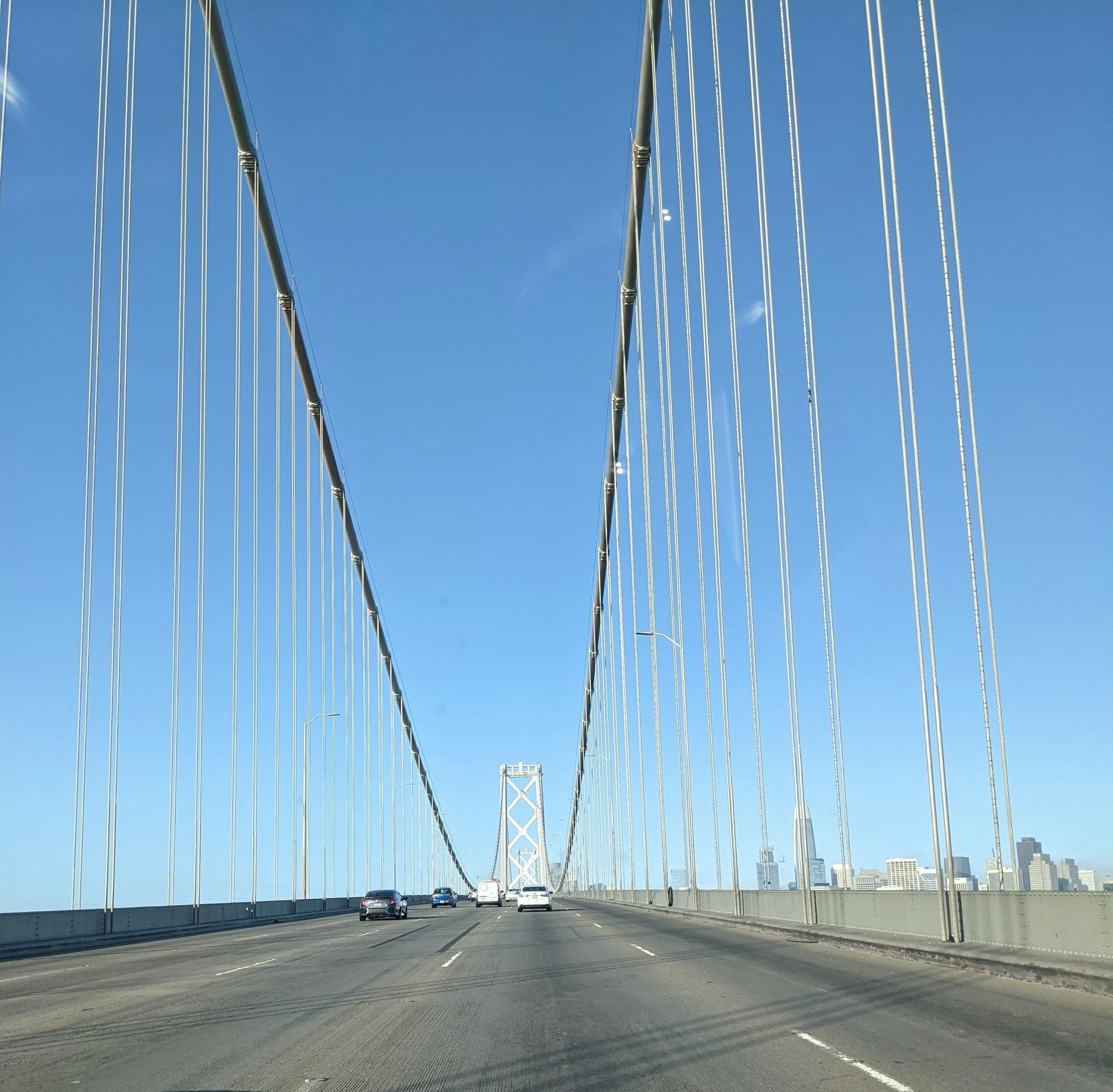 A car driving across a bridge on a clear day photo – Free Golden gate ...