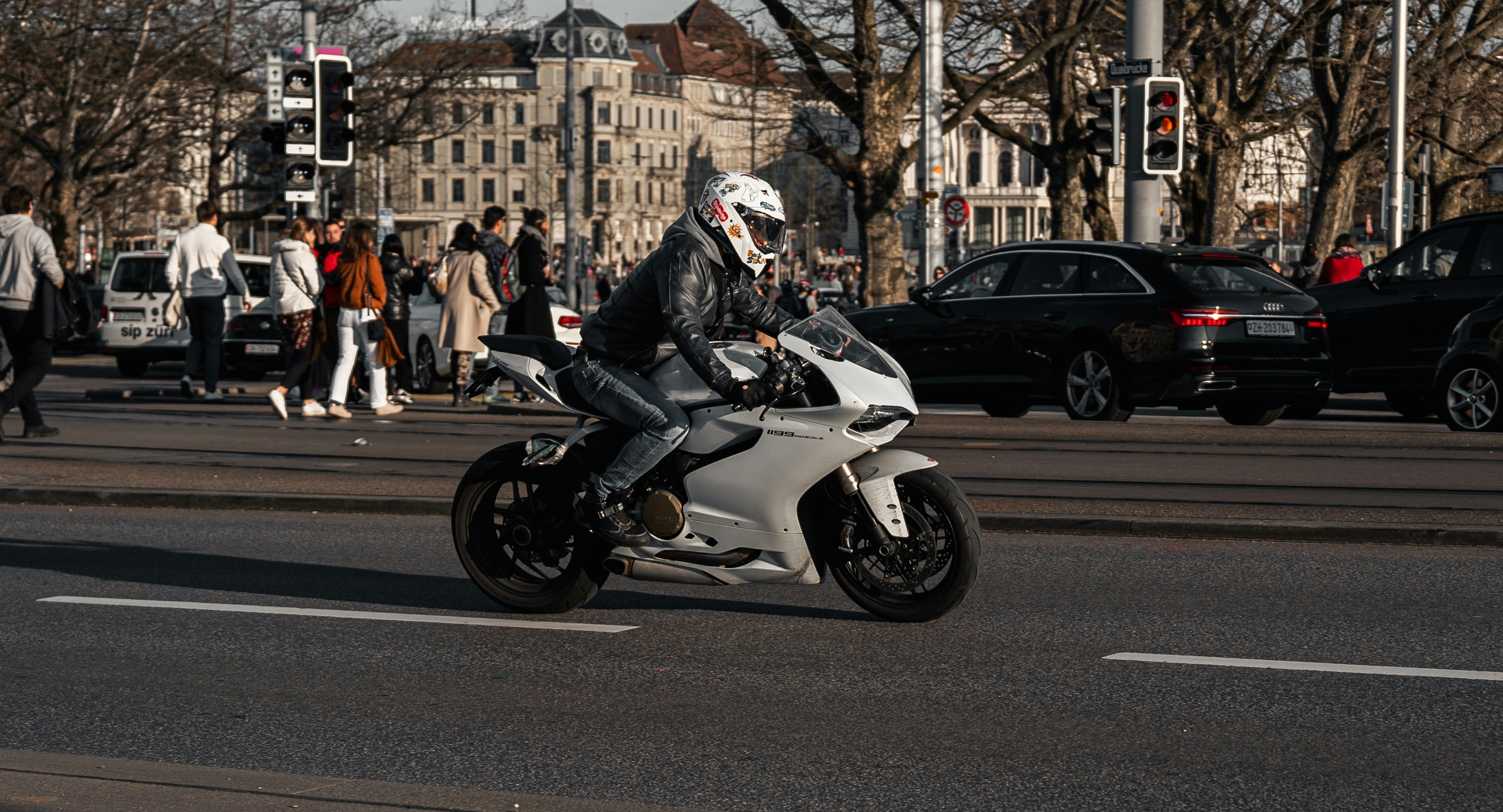 A person riding a motorcycle on a city street photo – Free Zürich Image ...