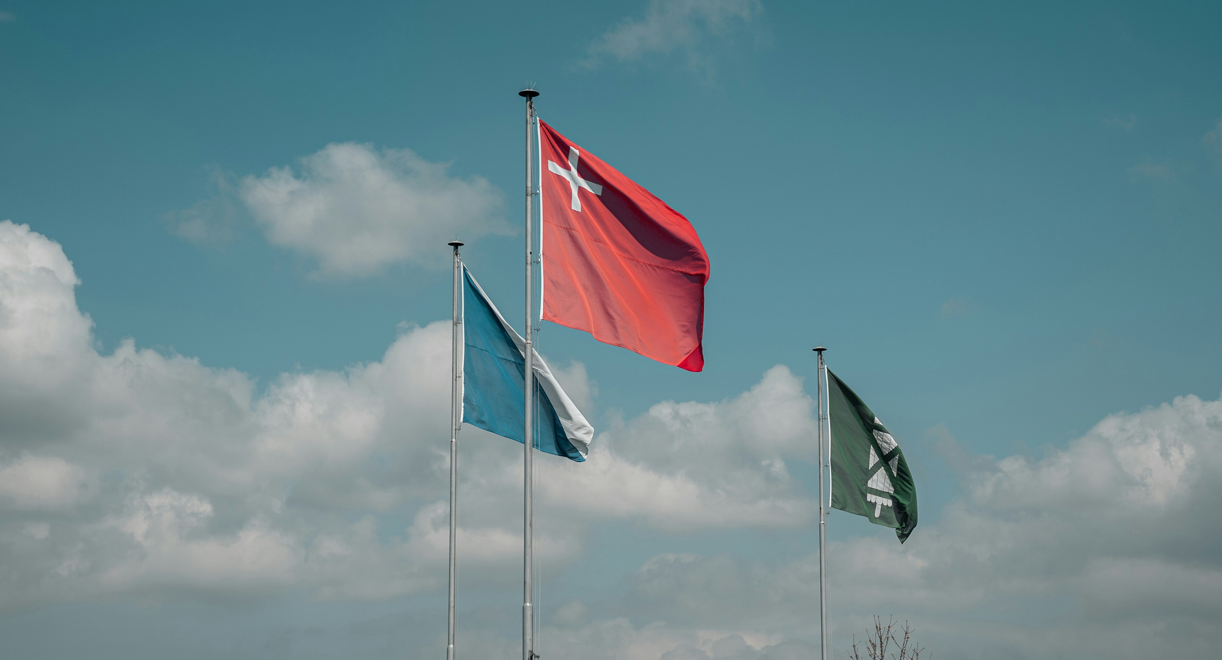 Three flags flying in the wind on a cloudy day photo – Free Rapperswil ...