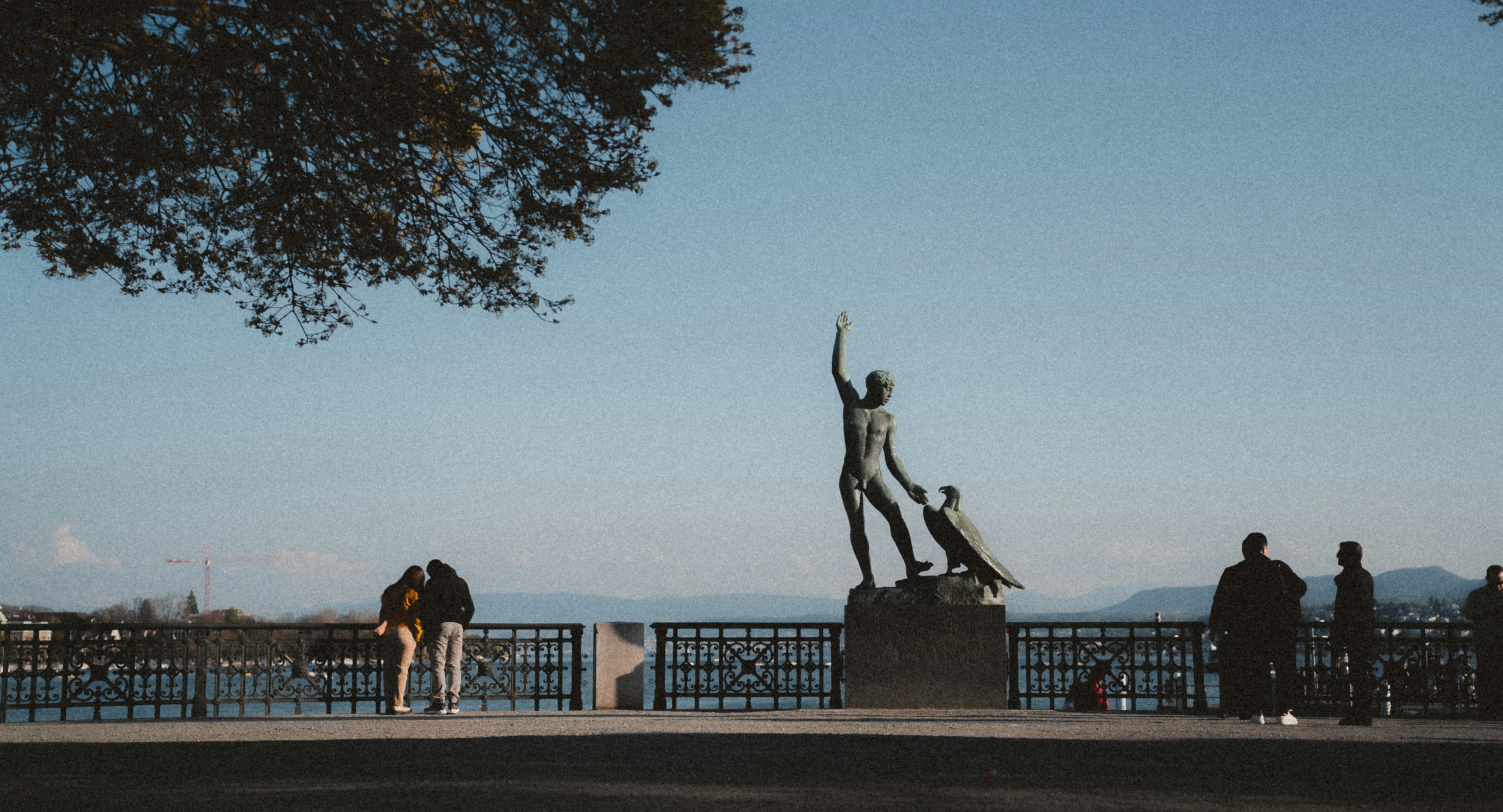 A group of people standing around a statue photo – Free Zürich Image on ...