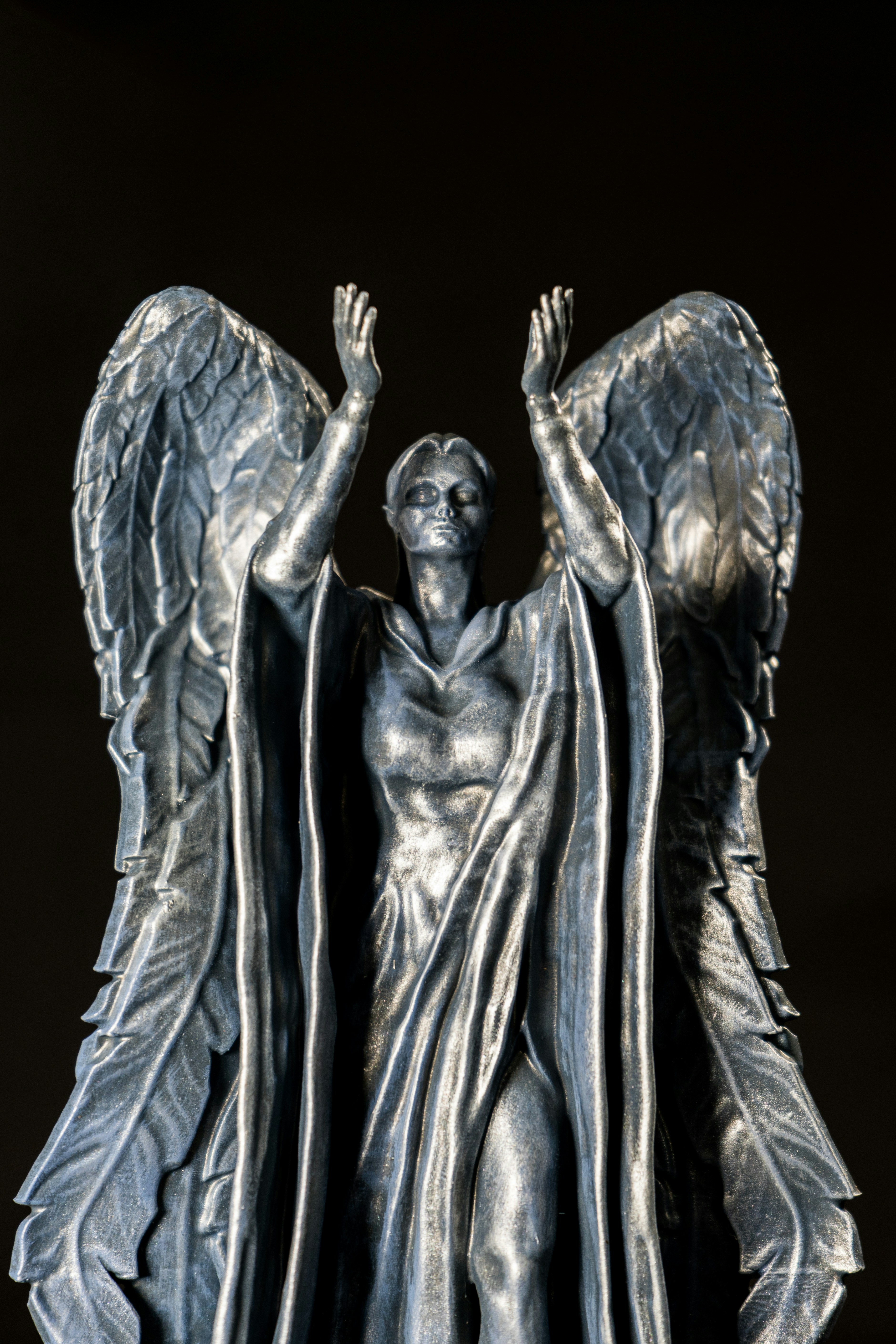 A statue of an angel holding his hands up photo – Free Woman Image on ...