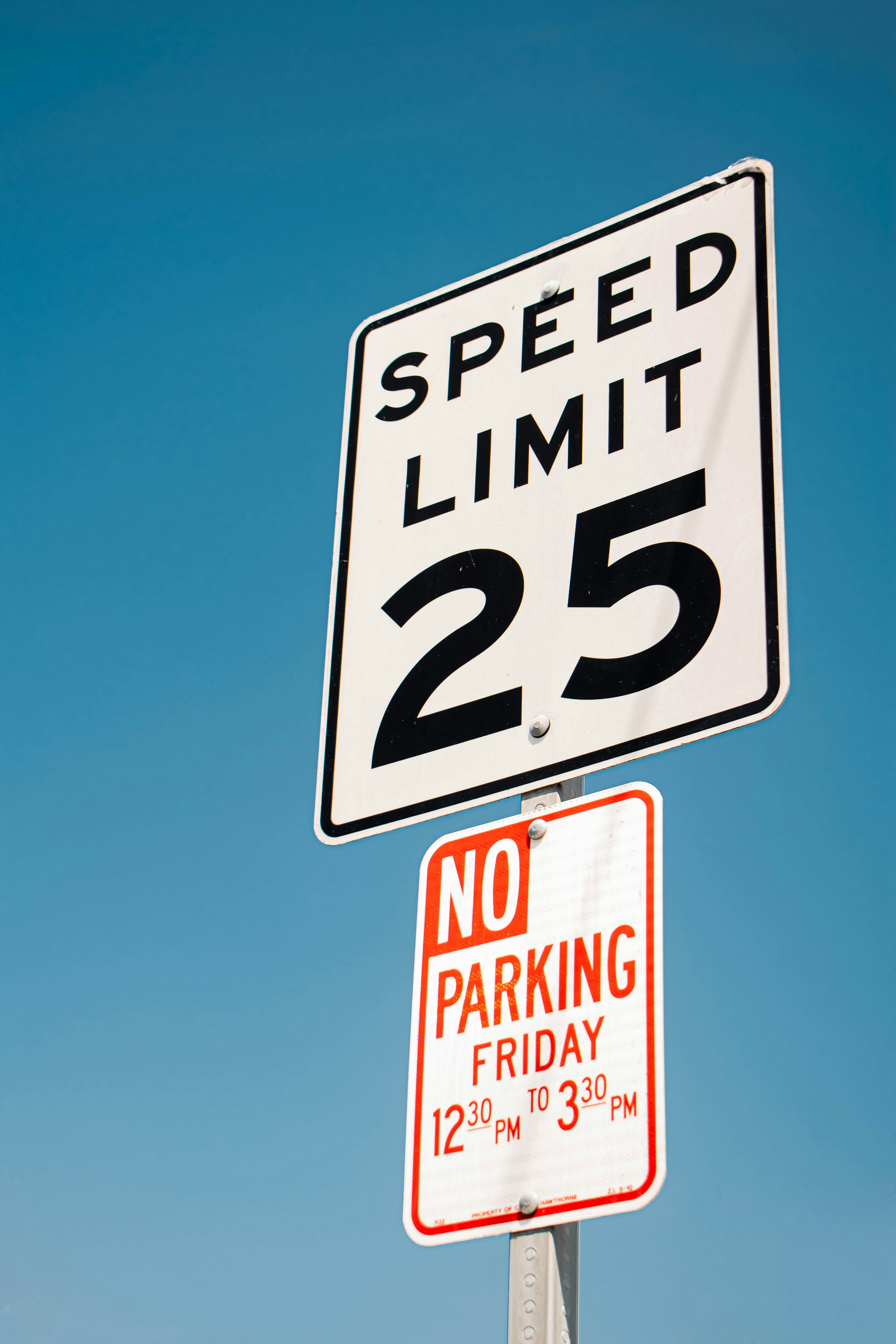 A speed limit sign and a no parking sign photo – Free City Image on ...