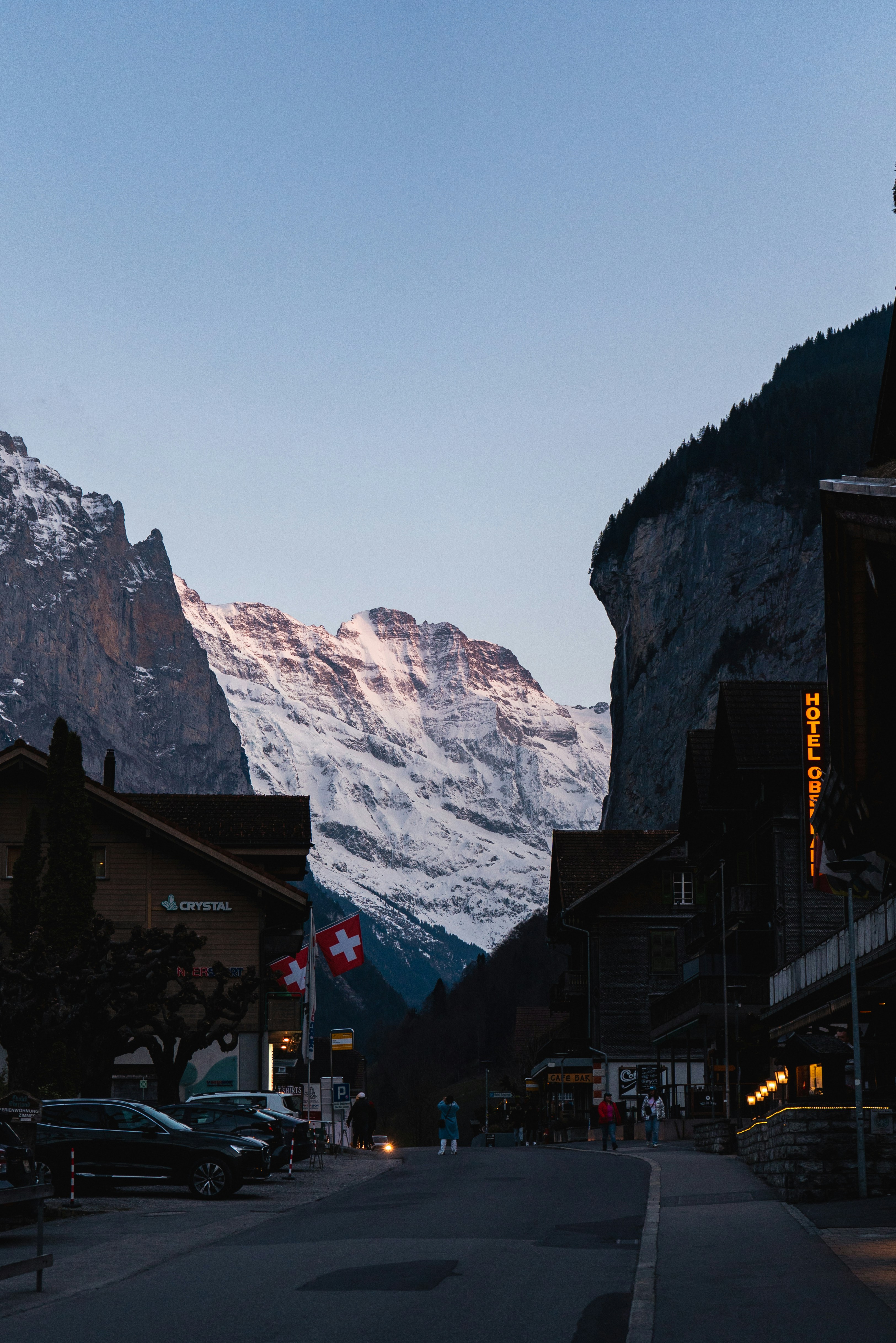 Alpine Street at Dusk: Snow-Capped Peaks Framing a Quaint Swiss Village