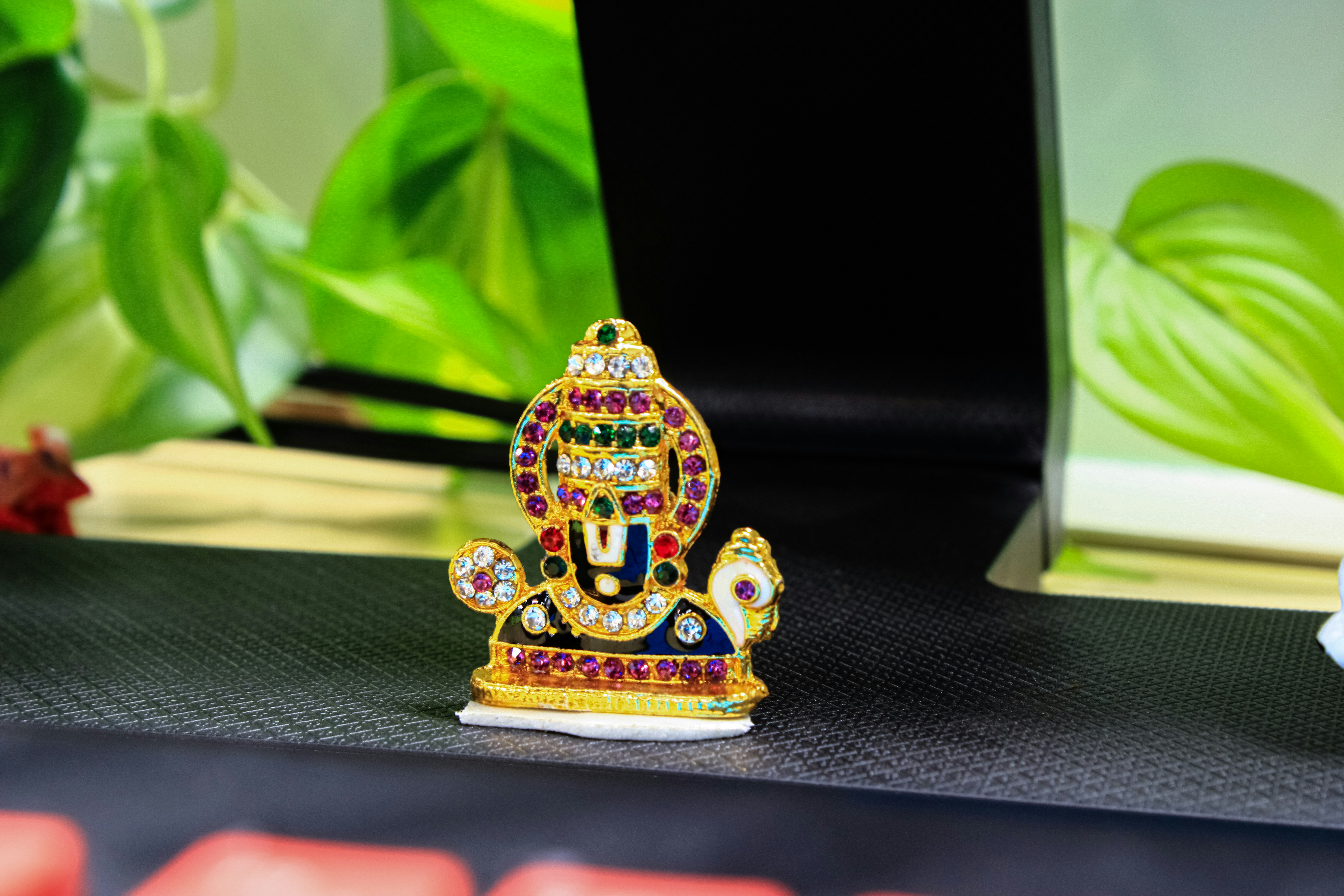 A small statue of a god on a table photo – Free Swipe park view Image ...