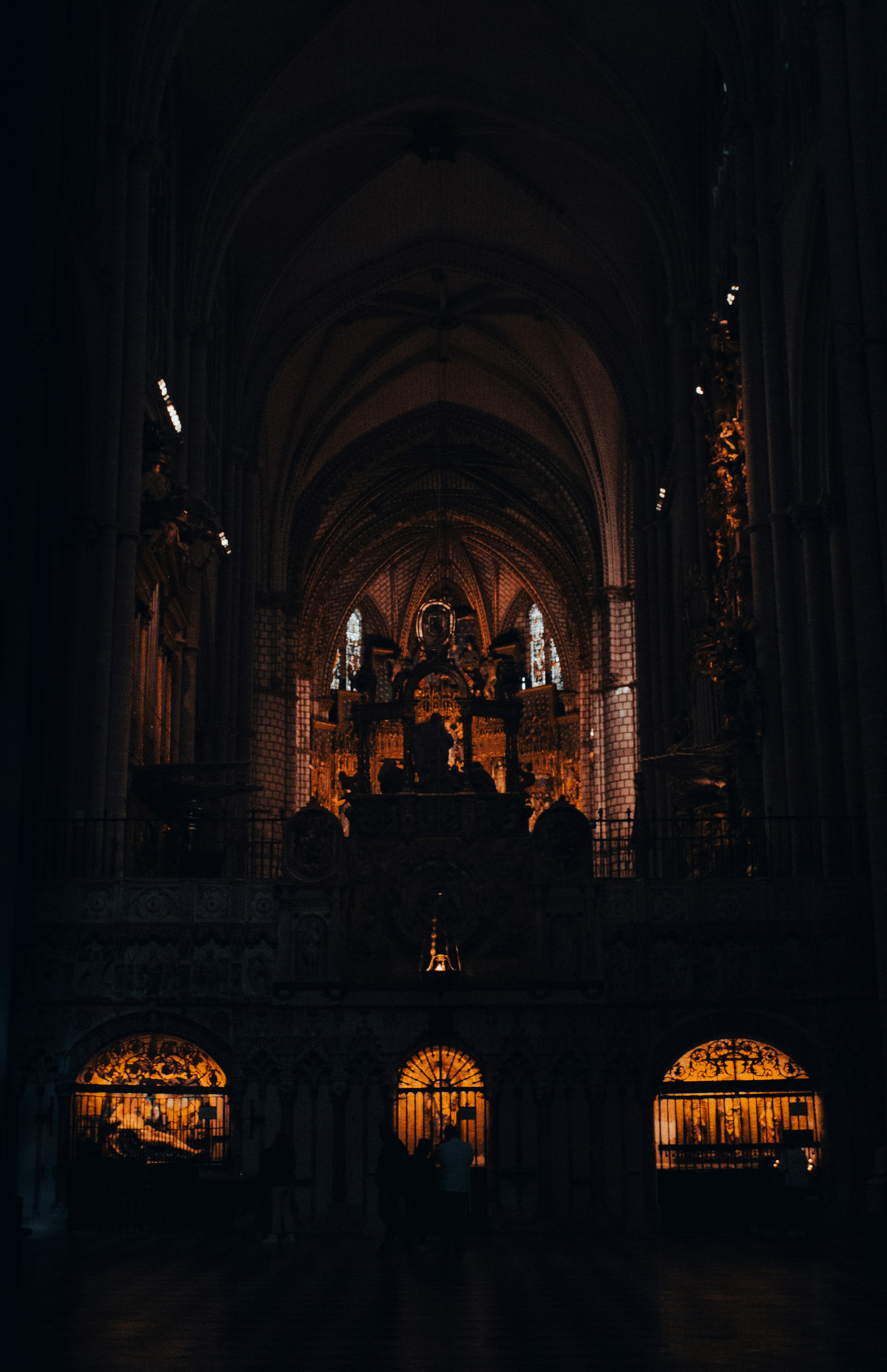 A dark cathedral with lights shining in the windows photo – Free ...