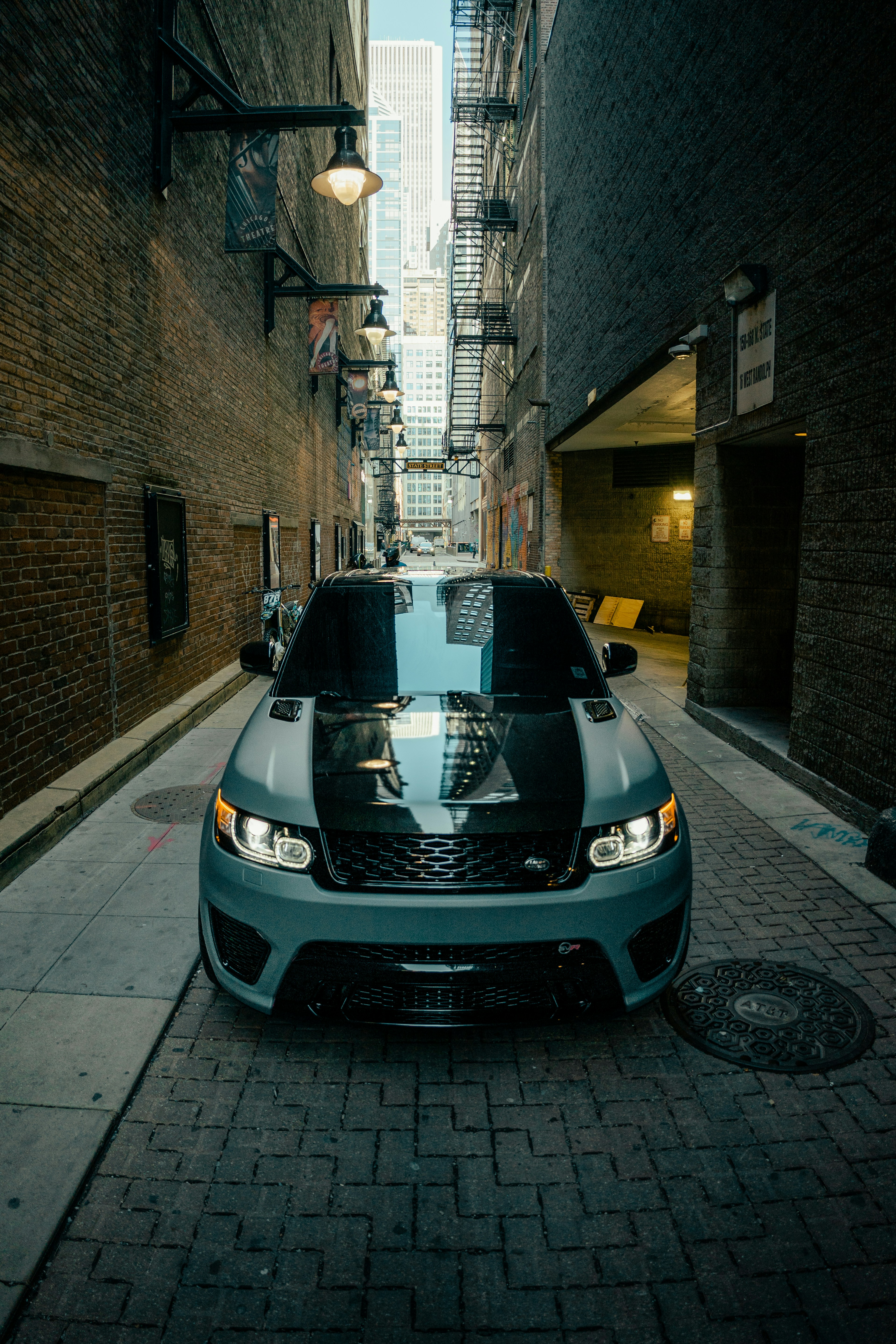 Alleyway Apex: The SUV Stares Down a Brick Canyon