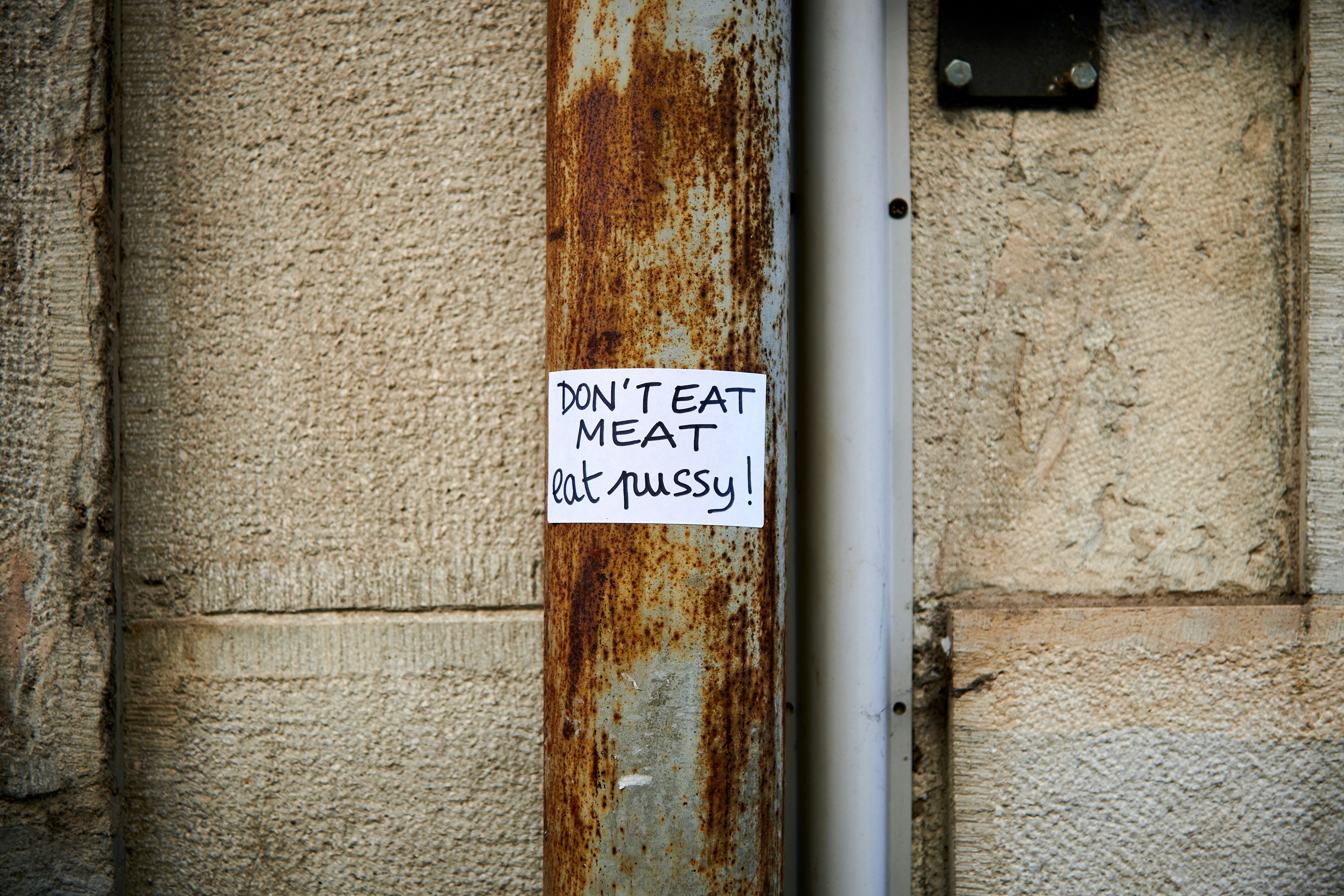 A rusted metal pole with a sign on it photo – Free Corrosion Image on ...