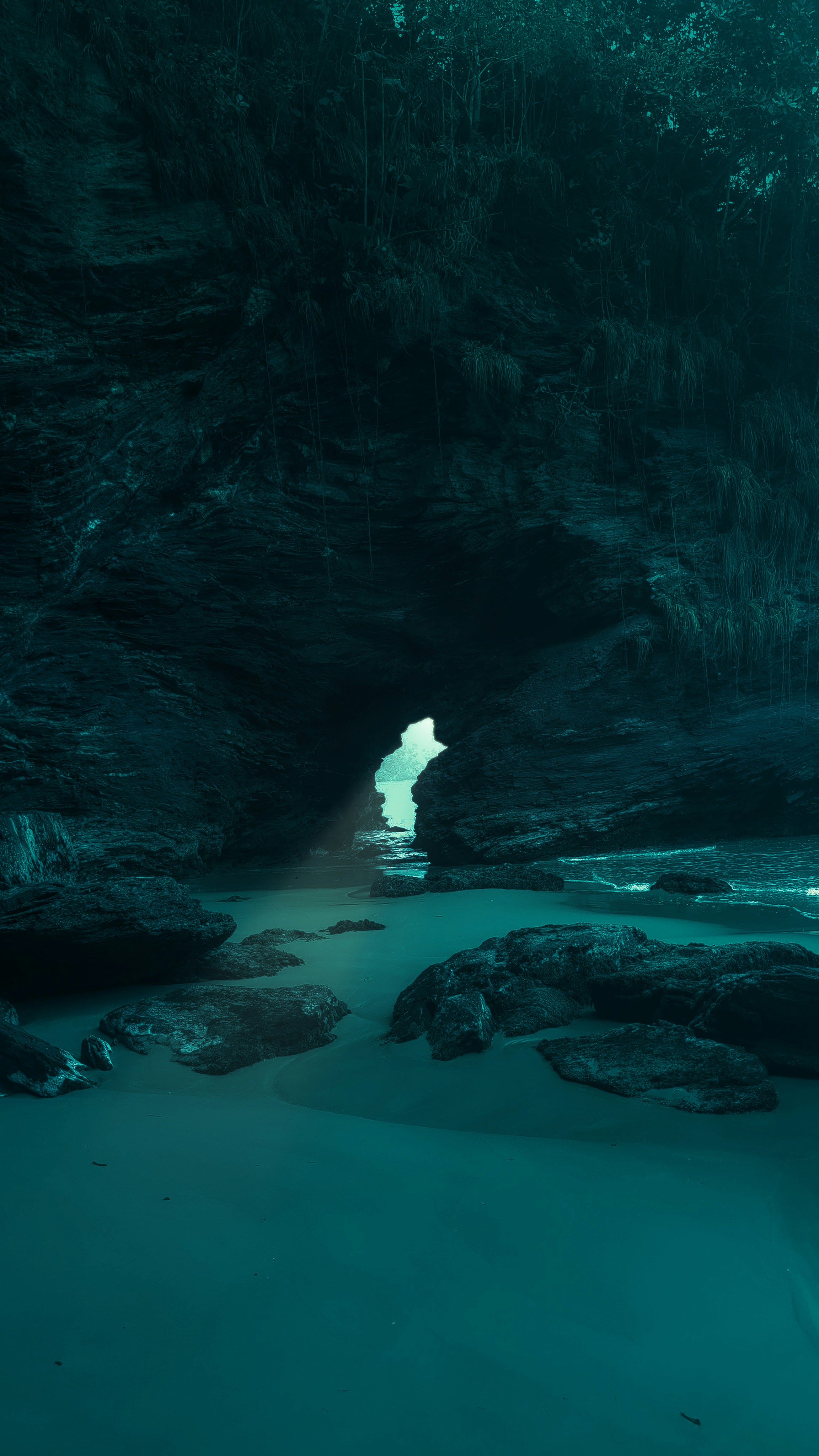 Teal Archway: Light Through a Hidden Sea Cave