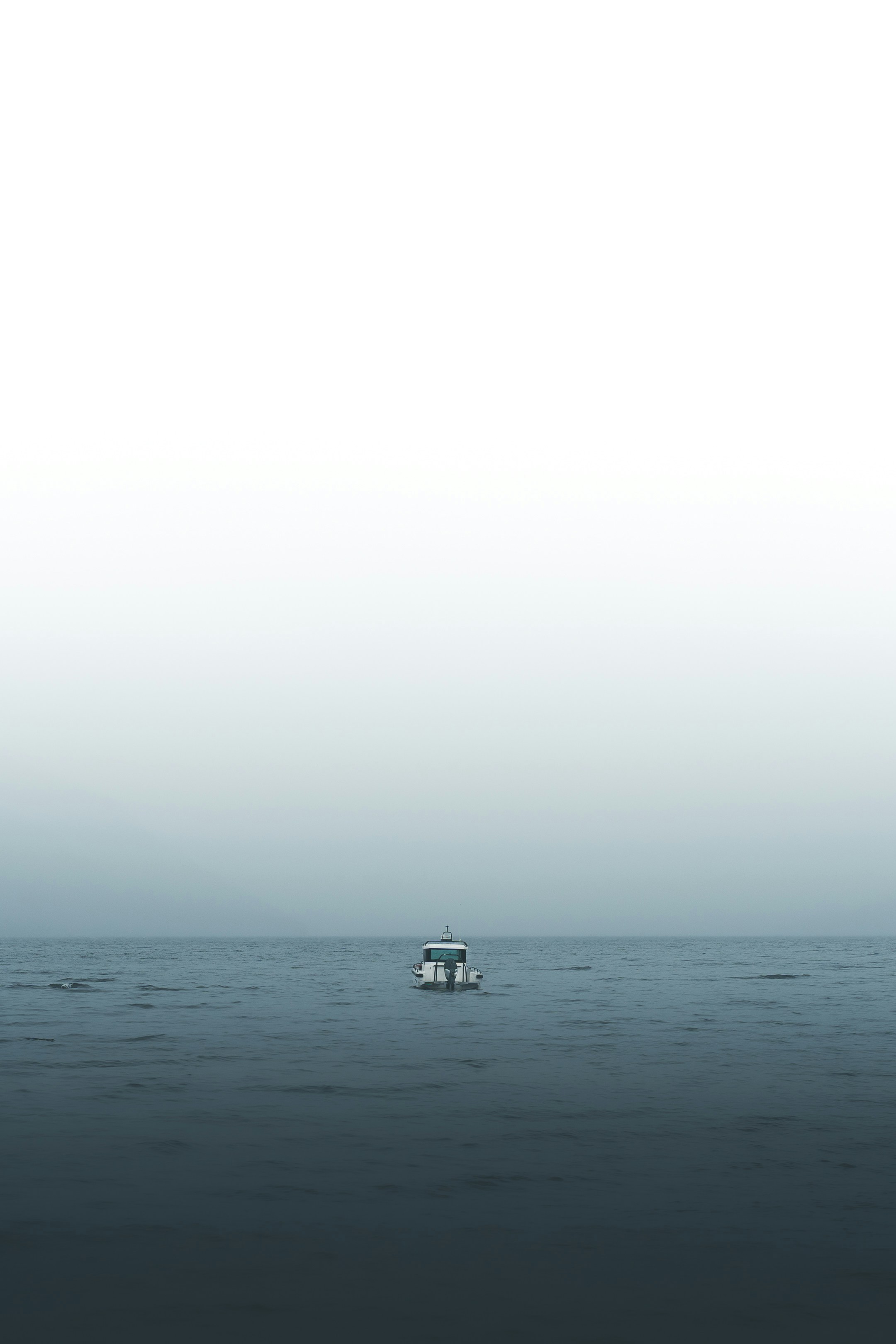 A Lone Boat on a Velvet Sea Under Expansive Sky
