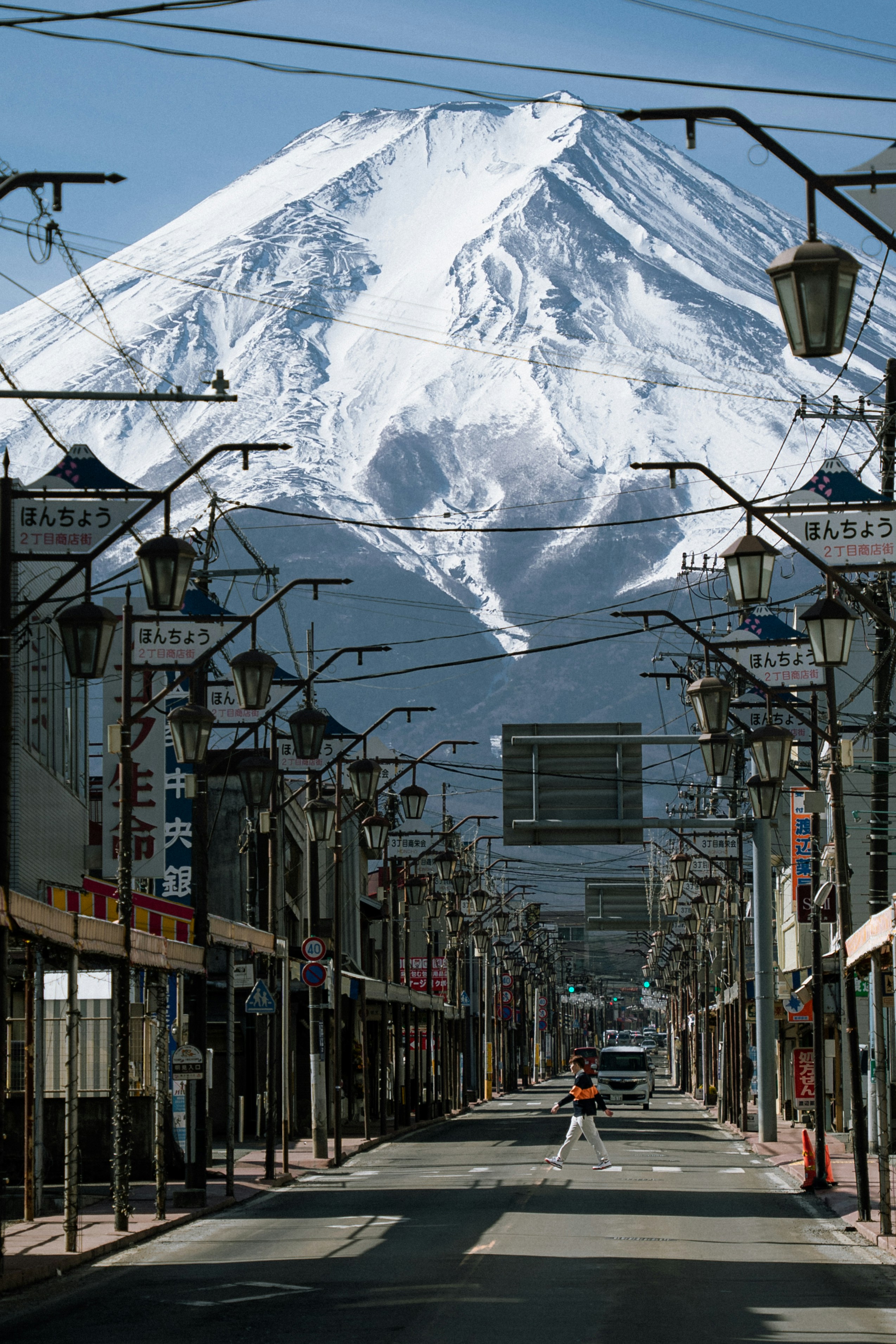 Snowbound Fuji Looms Over a Lantern-Lined Street