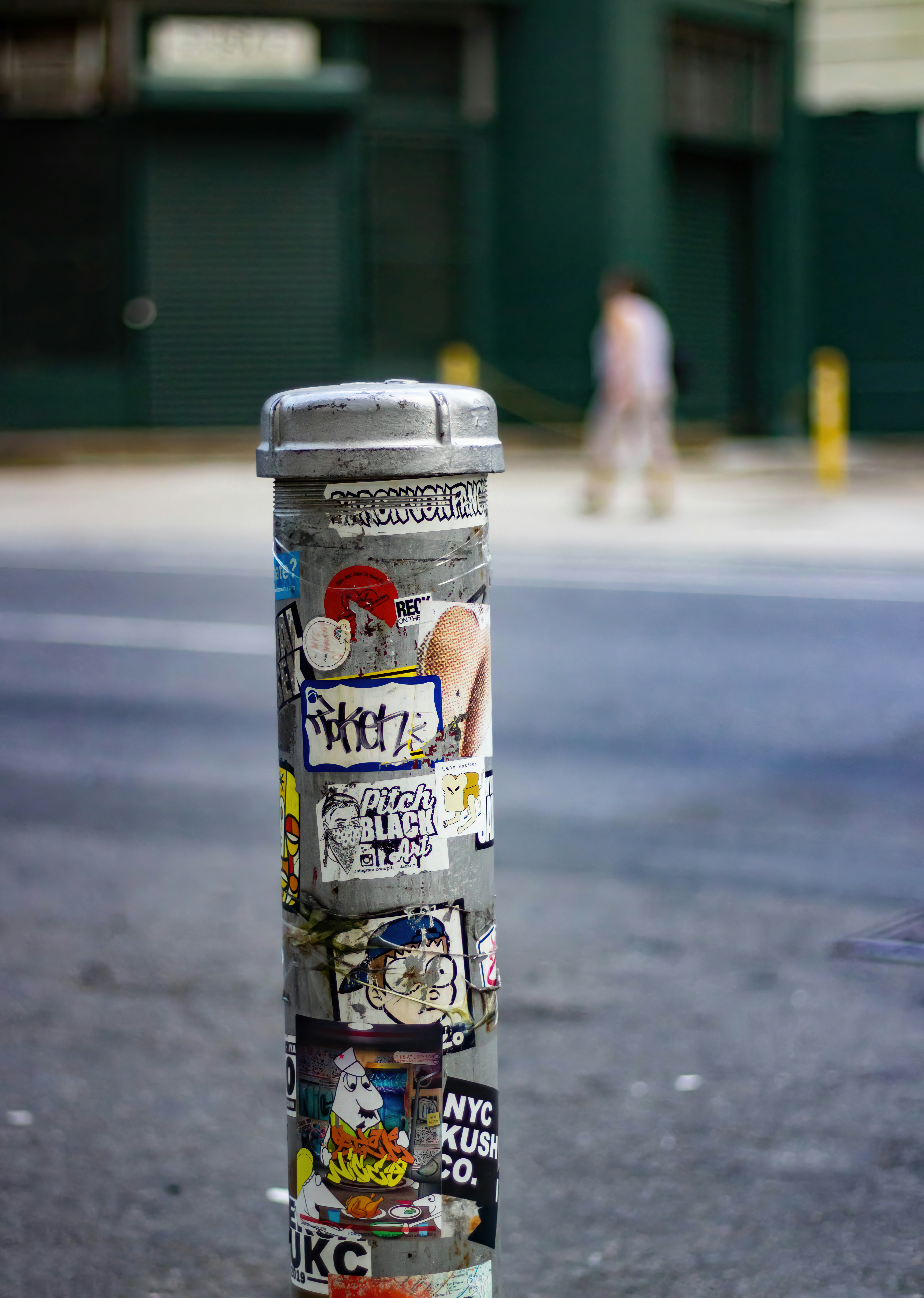 A pole that has a bunch of stickers on it photo – Free New york Image ...