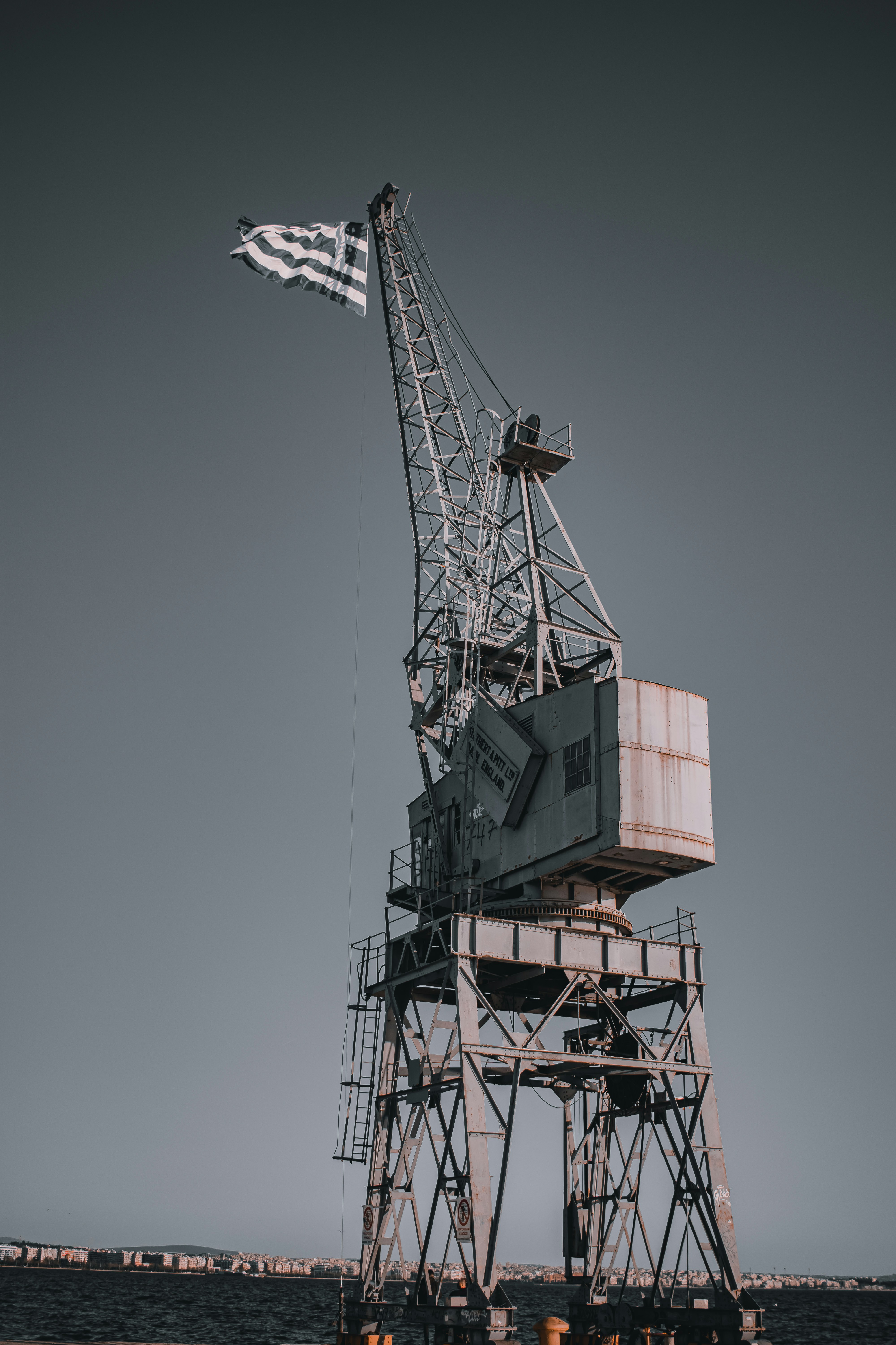 a large crane sitting on top of a body of water