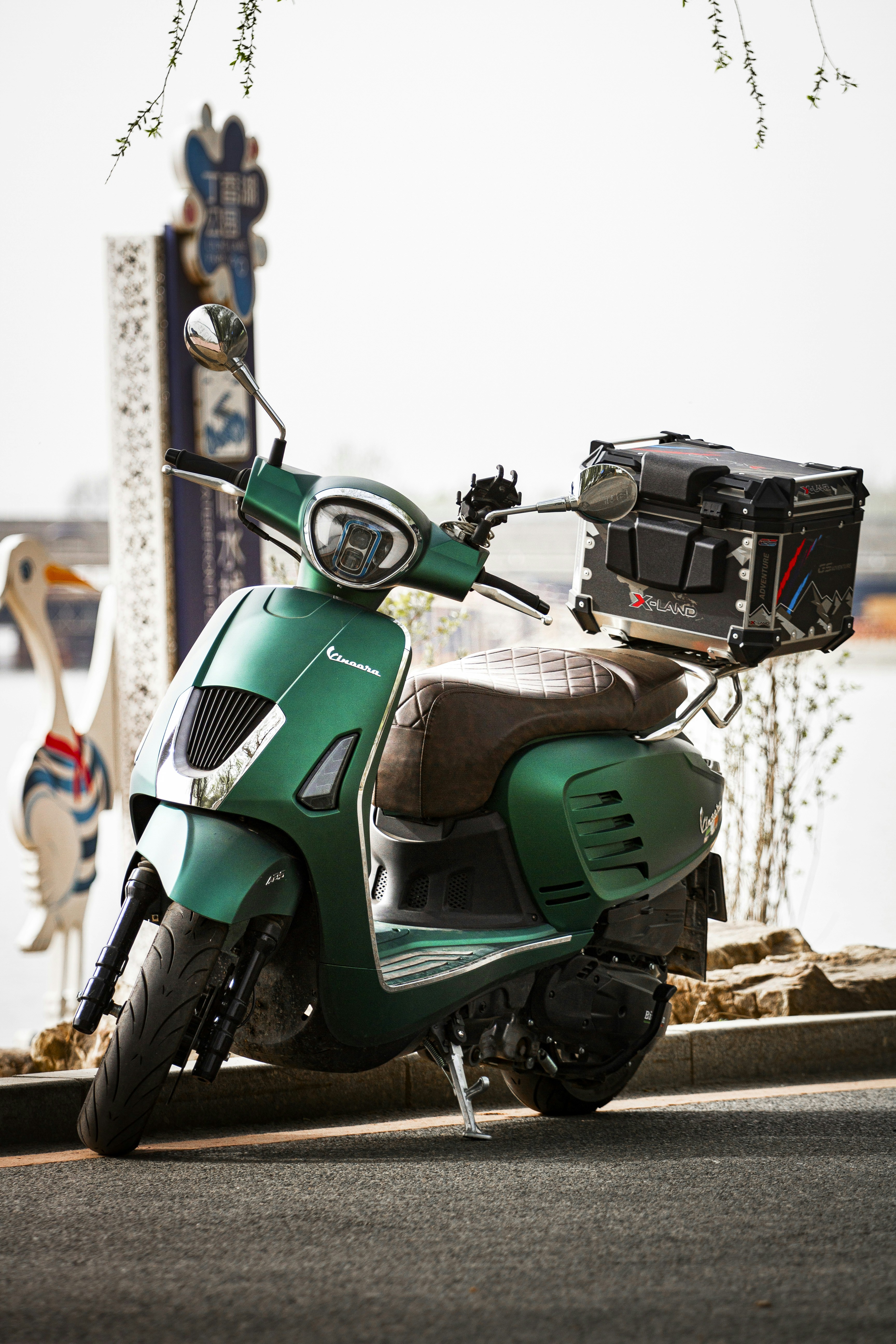 Curbside Courier: The Green Vespa with a Modular Top Case