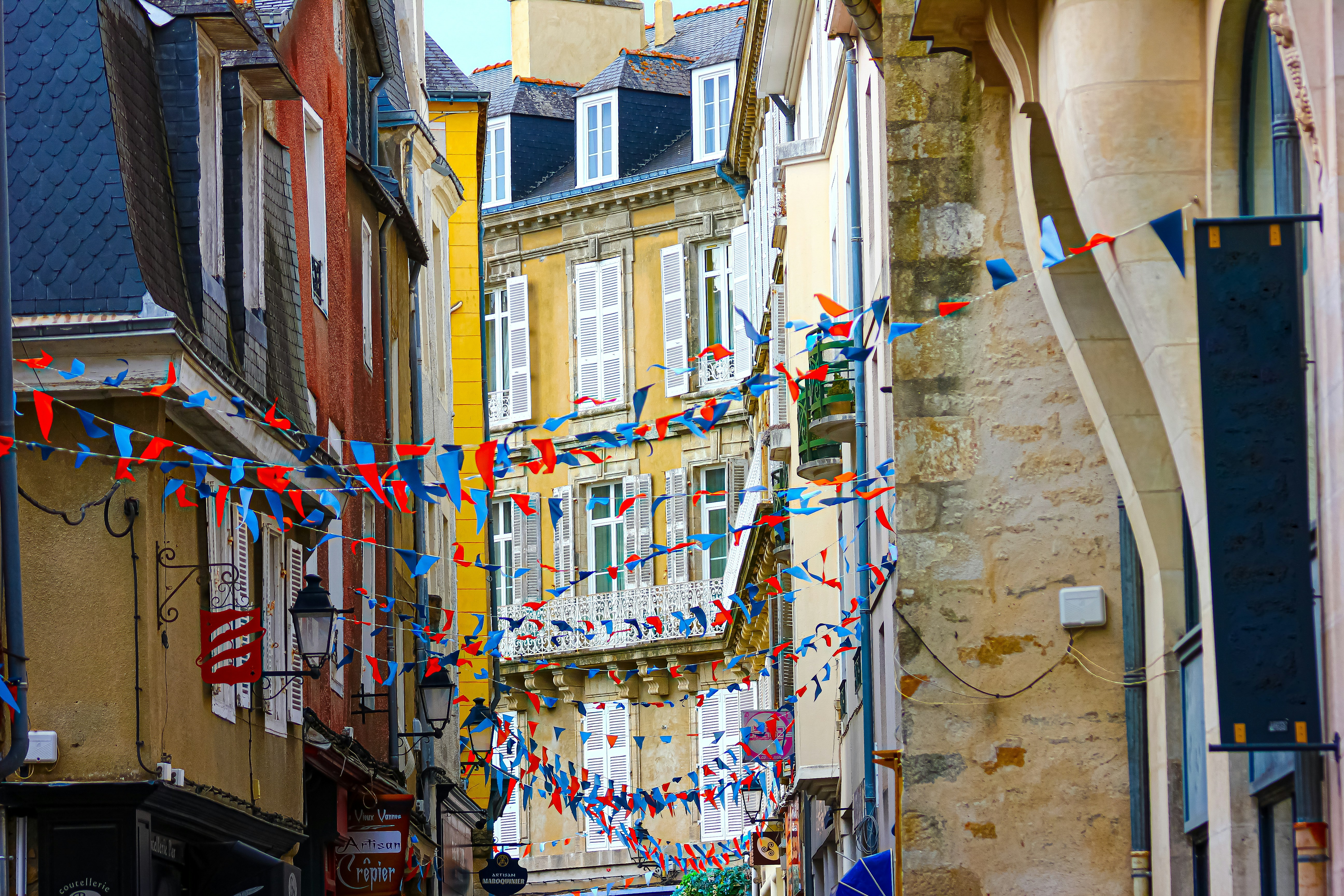Bunting Canopy Over a Stone-Walled Alley