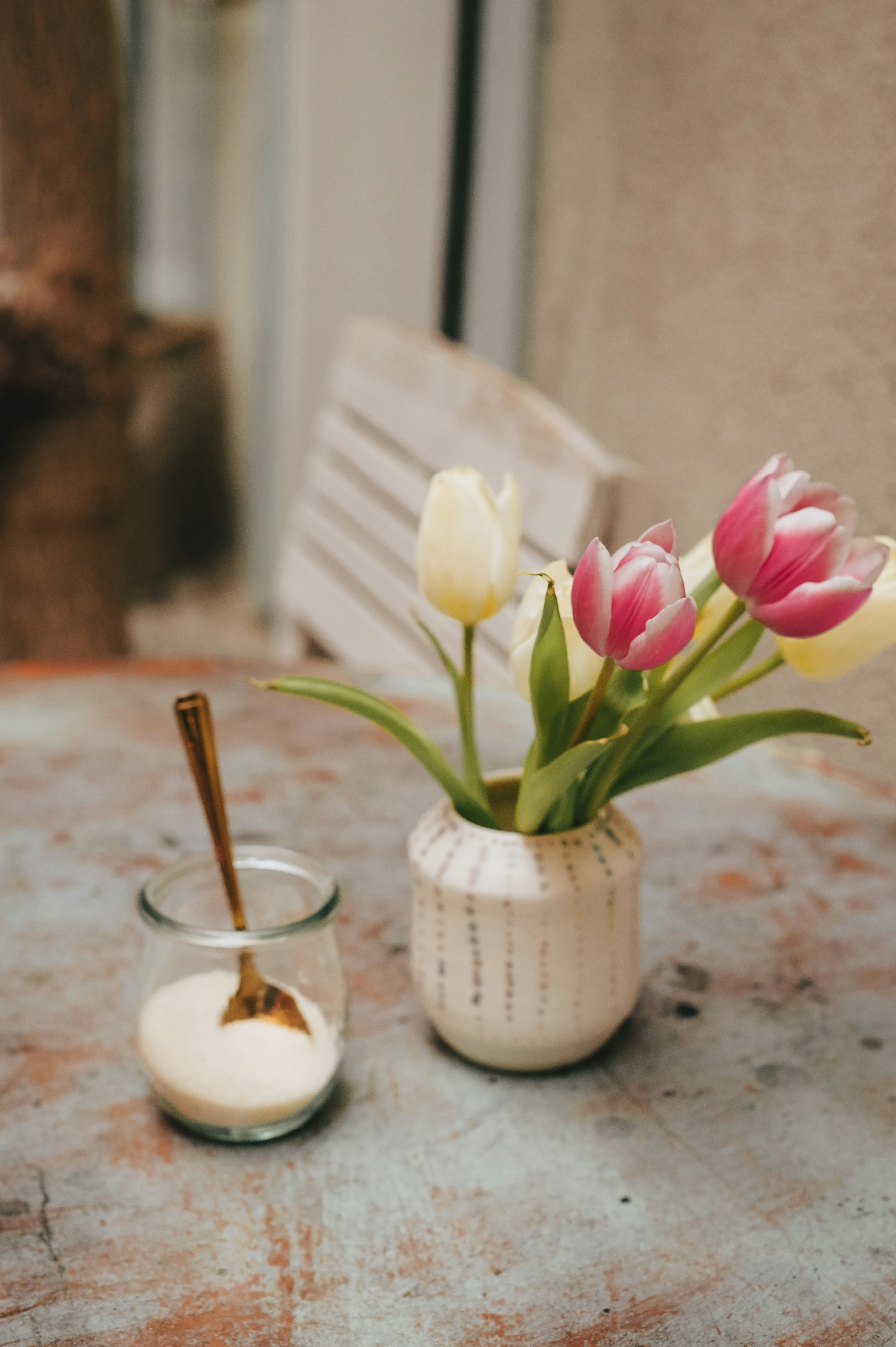 A vase with flowers and a spoon on a table photo – Free Flower Image on ...