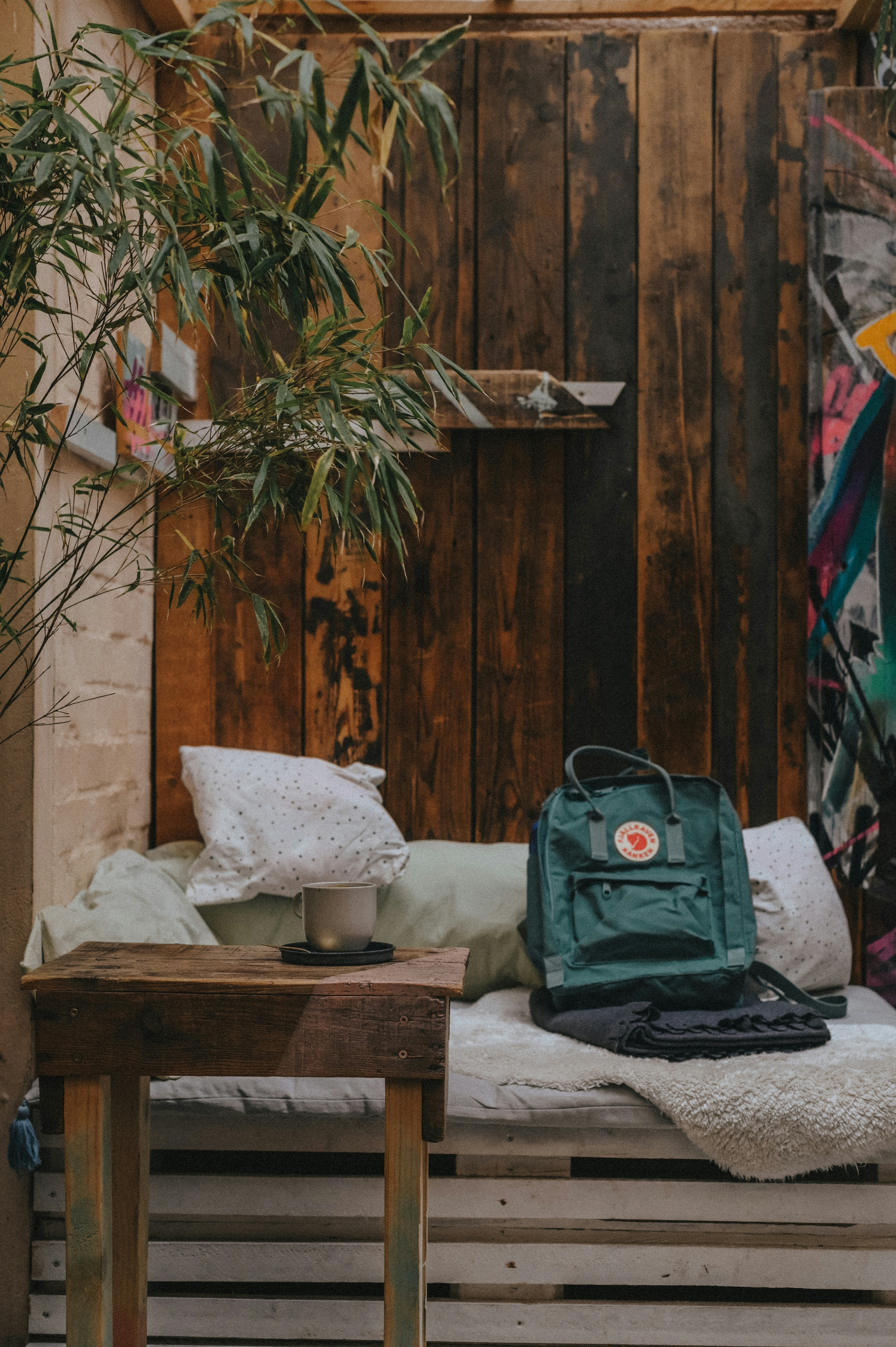 Teal Backpack in a Rustic Indoor Nook: Bamboo, Weathered Wood, and Soft Textures