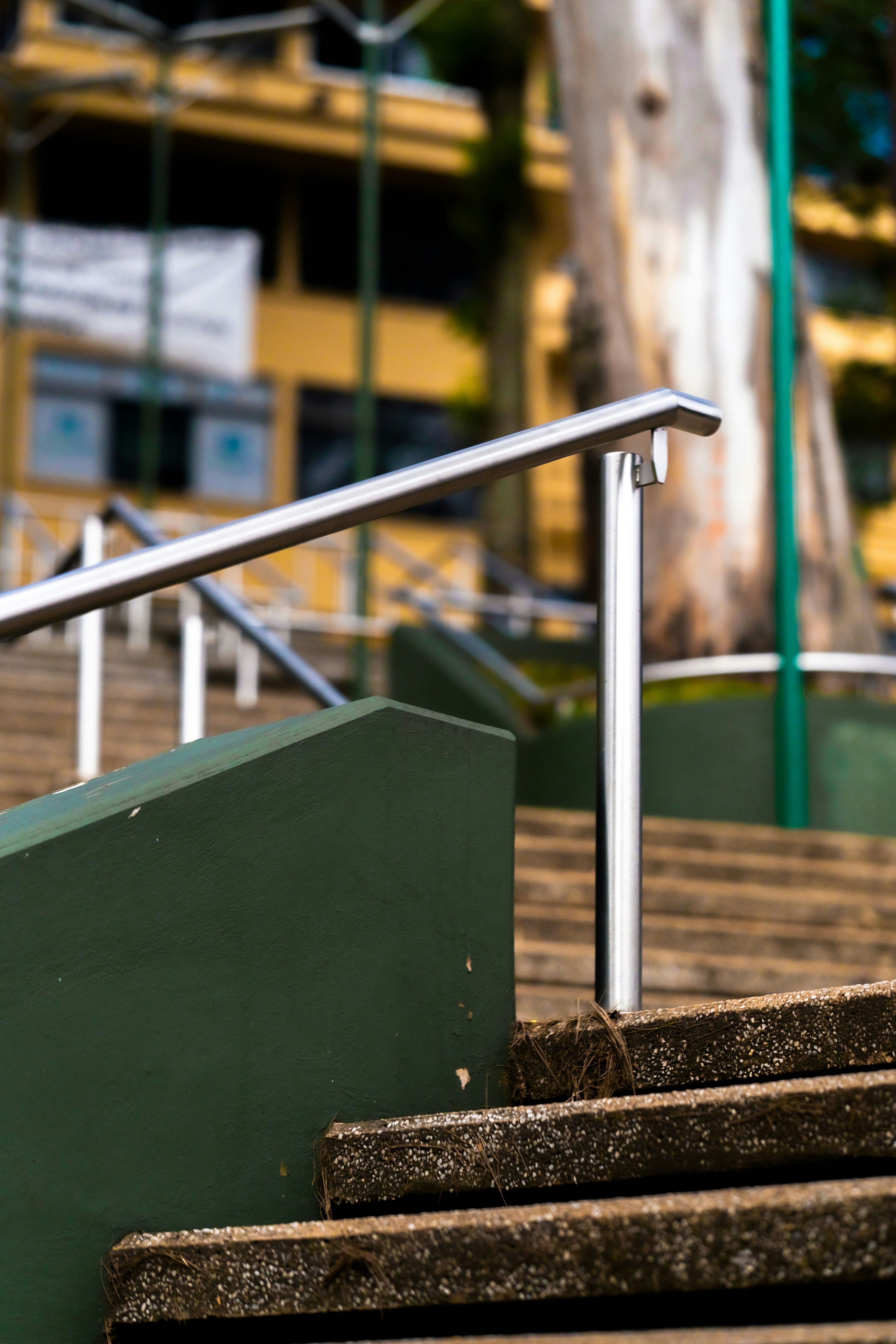 Glinting Handrail on a Quiet Campus Staircase