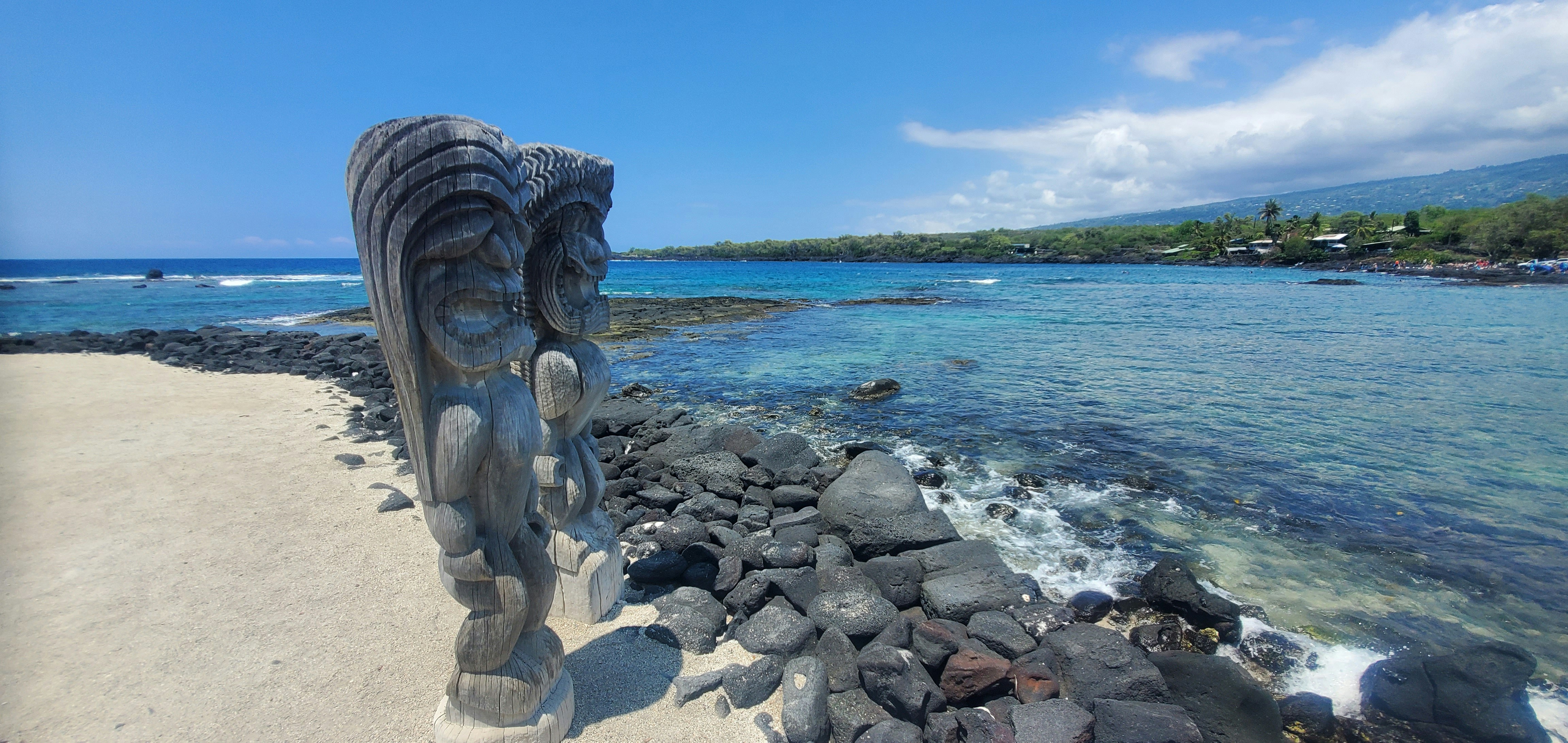 A statue of an angel on a beach next to the ocean photo – Free Hawaii ...