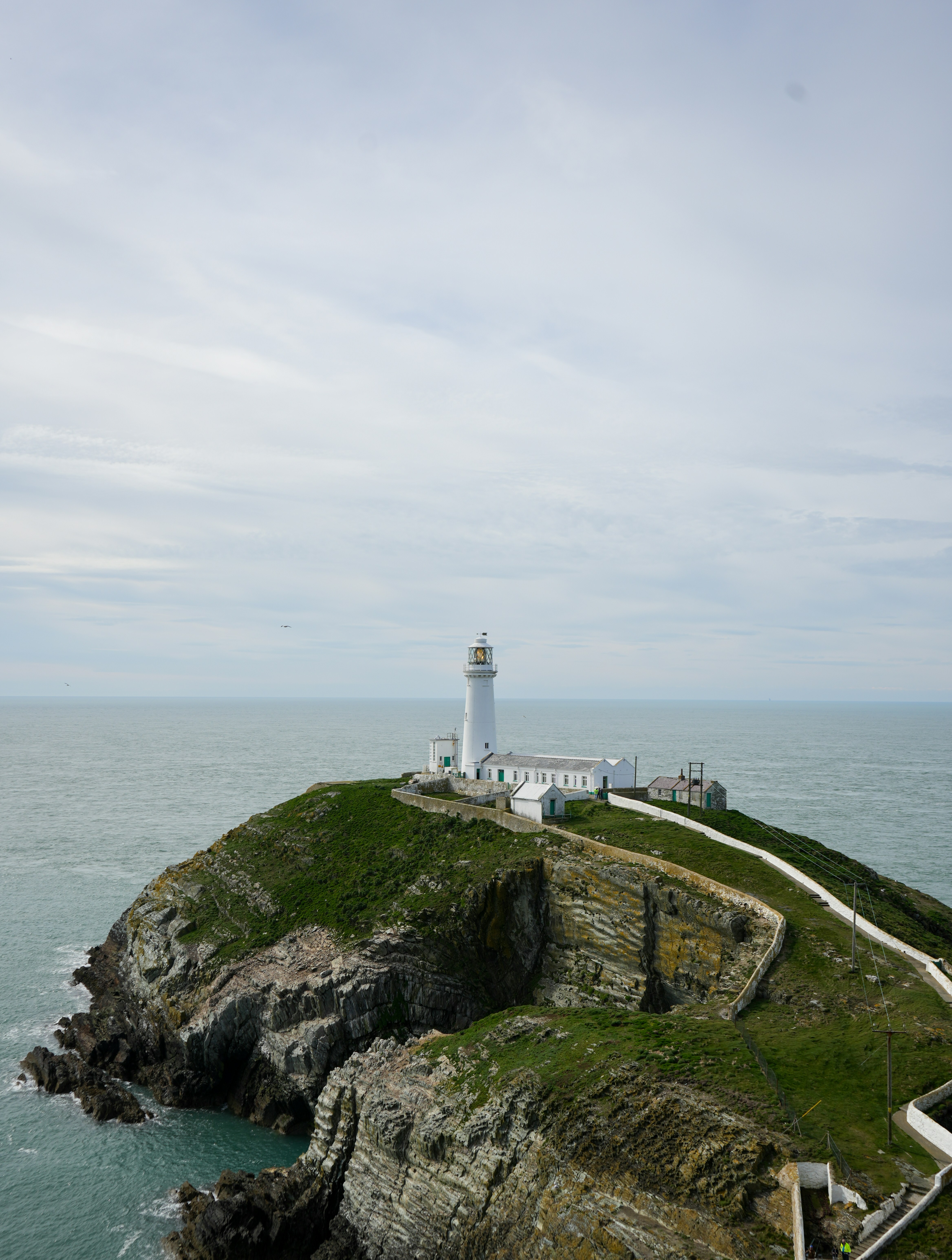 A lighthouse on top of a cliff near the ocean photo – Free Uk Image on ...