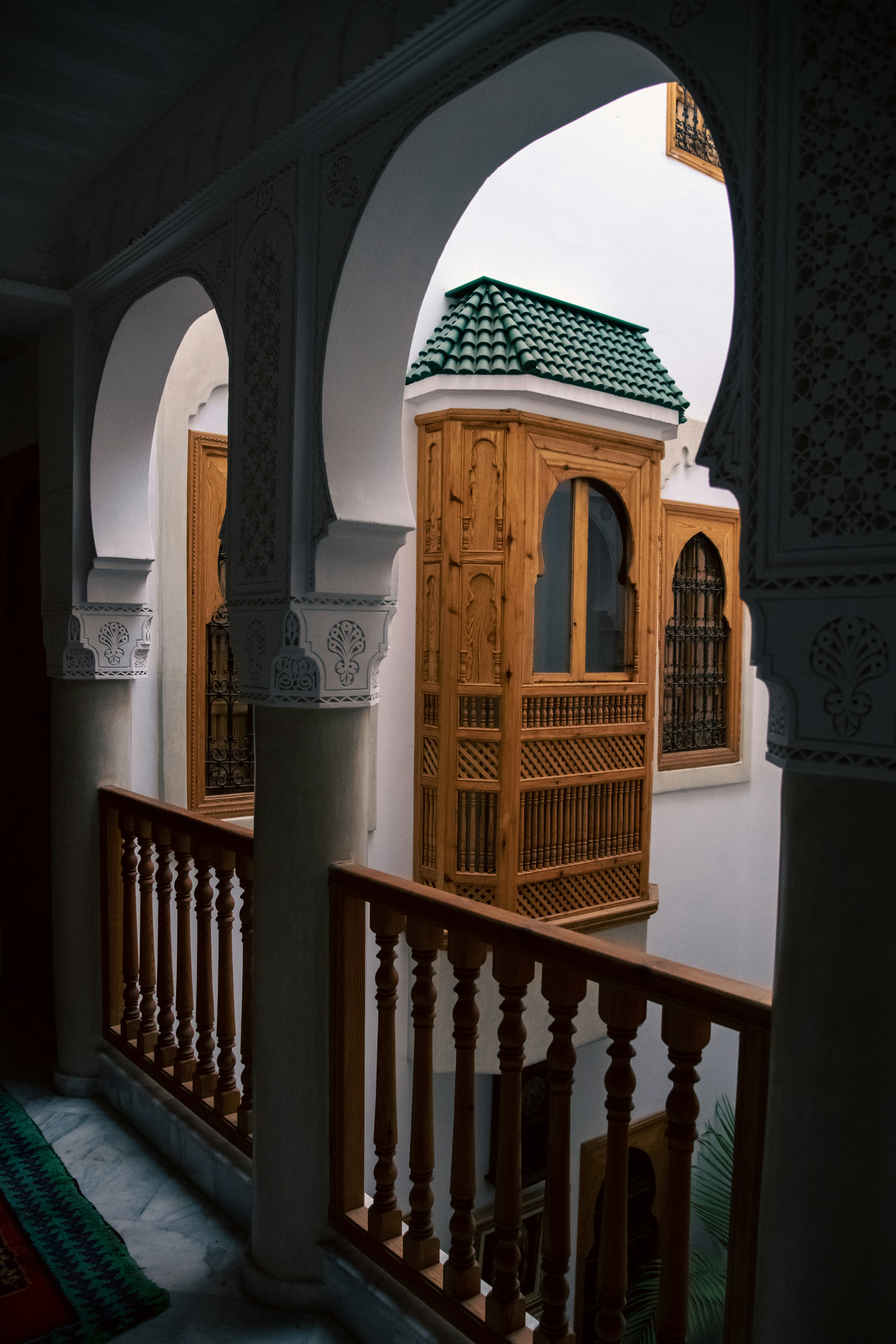 Archway Echoes: The Wooden Screen Framed by Moorish Arches