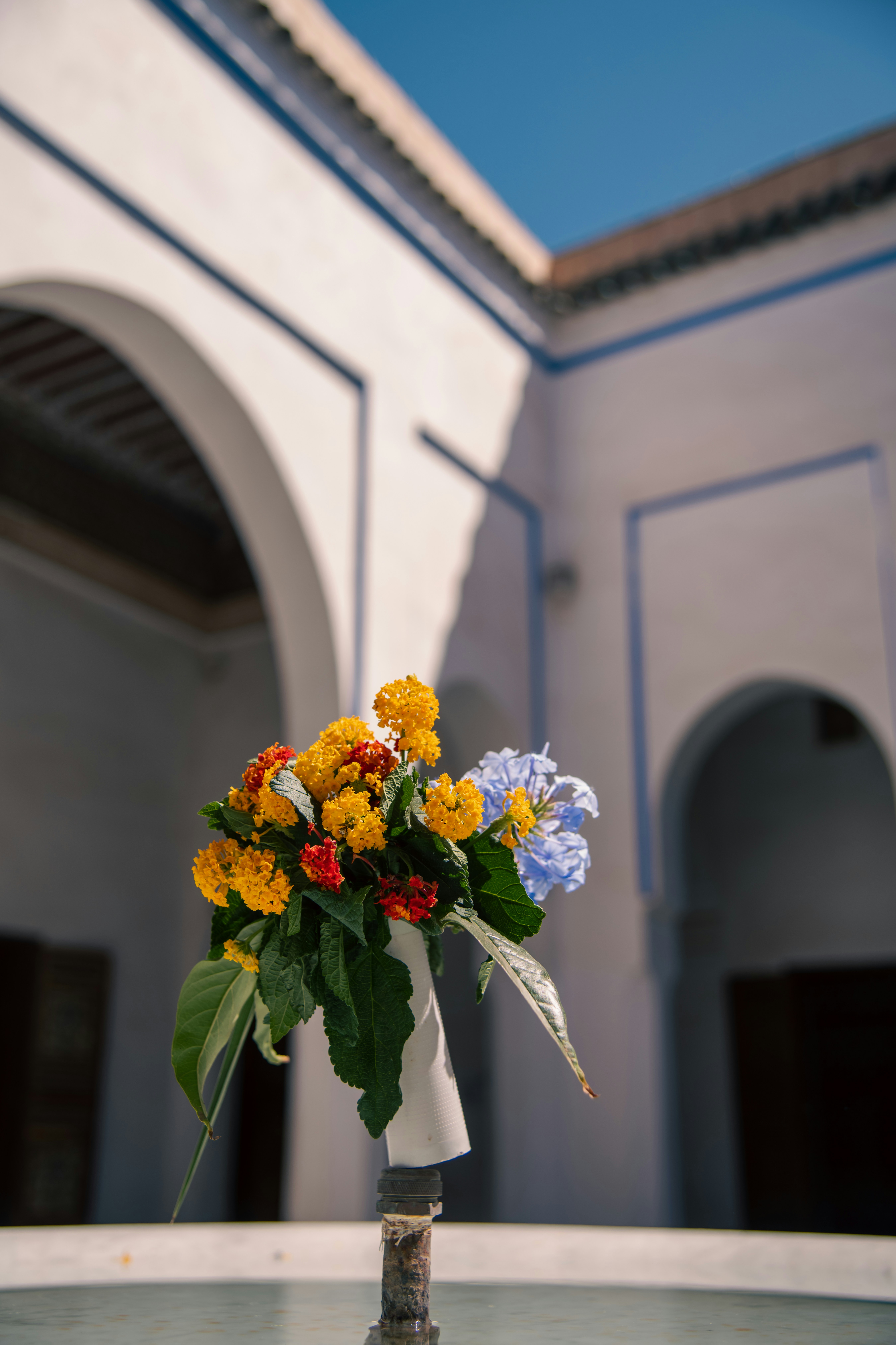 a vase filled with colorful flowers sitting on top of a table