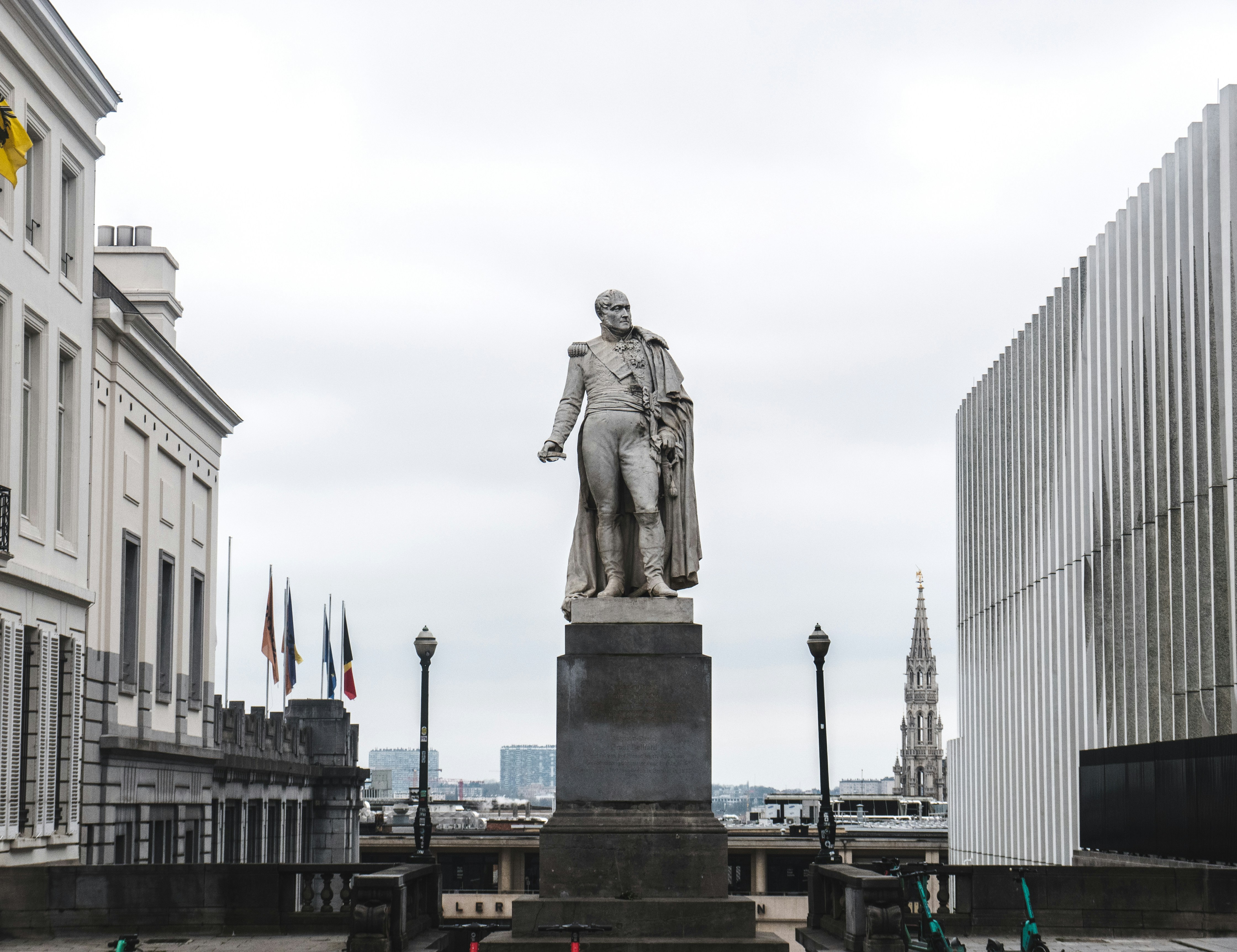 A statue of a man standing in front of a building photo – Free Building ...