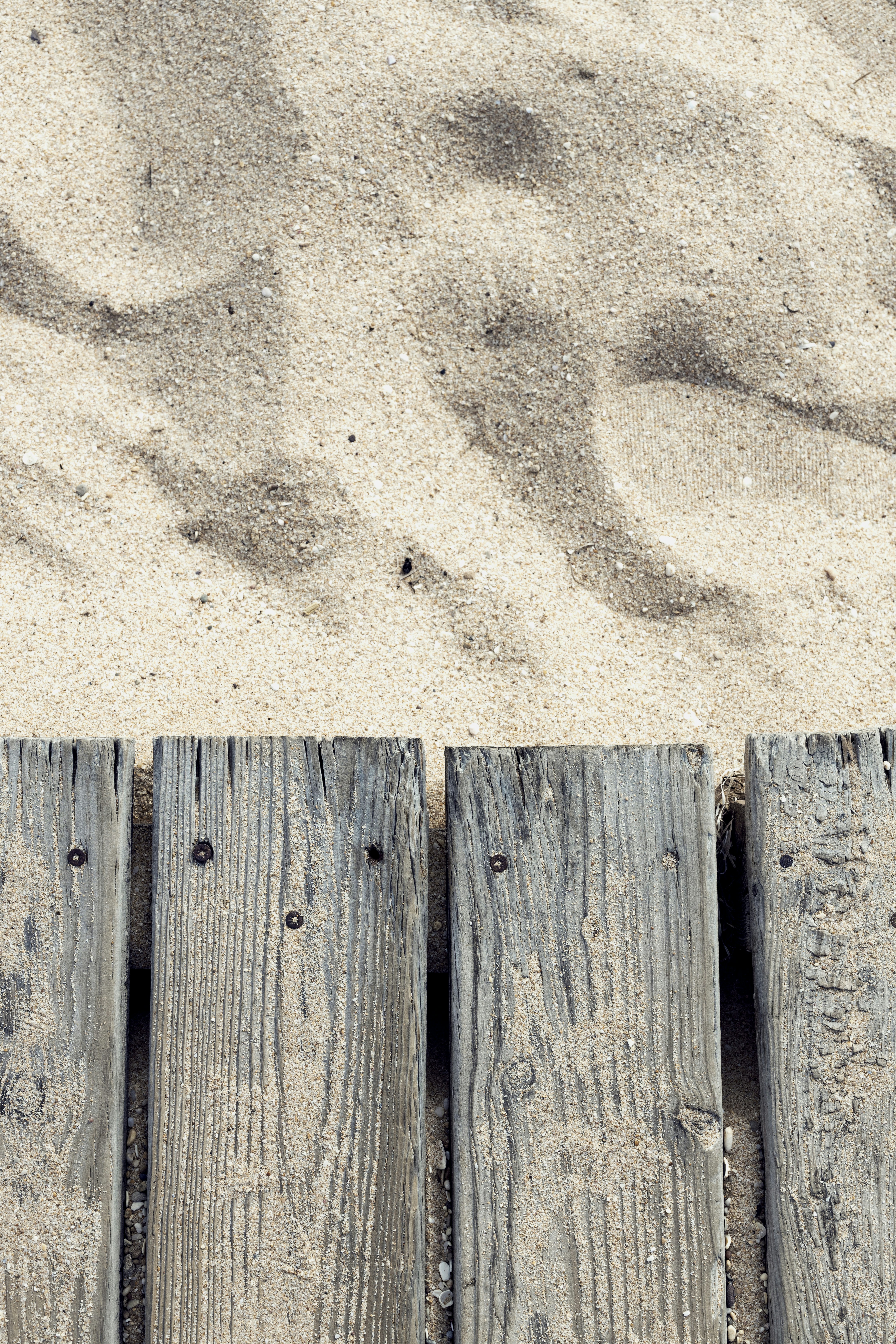 Weathered Planks at the Sand Edge: A Quiet Beach Frame