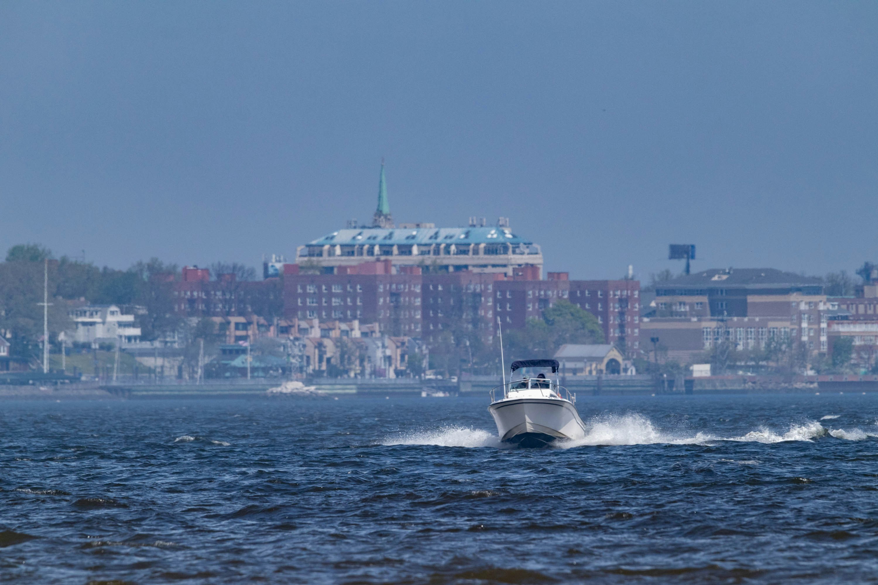 Urban Waterscape: Boat Against a City Backdrop
