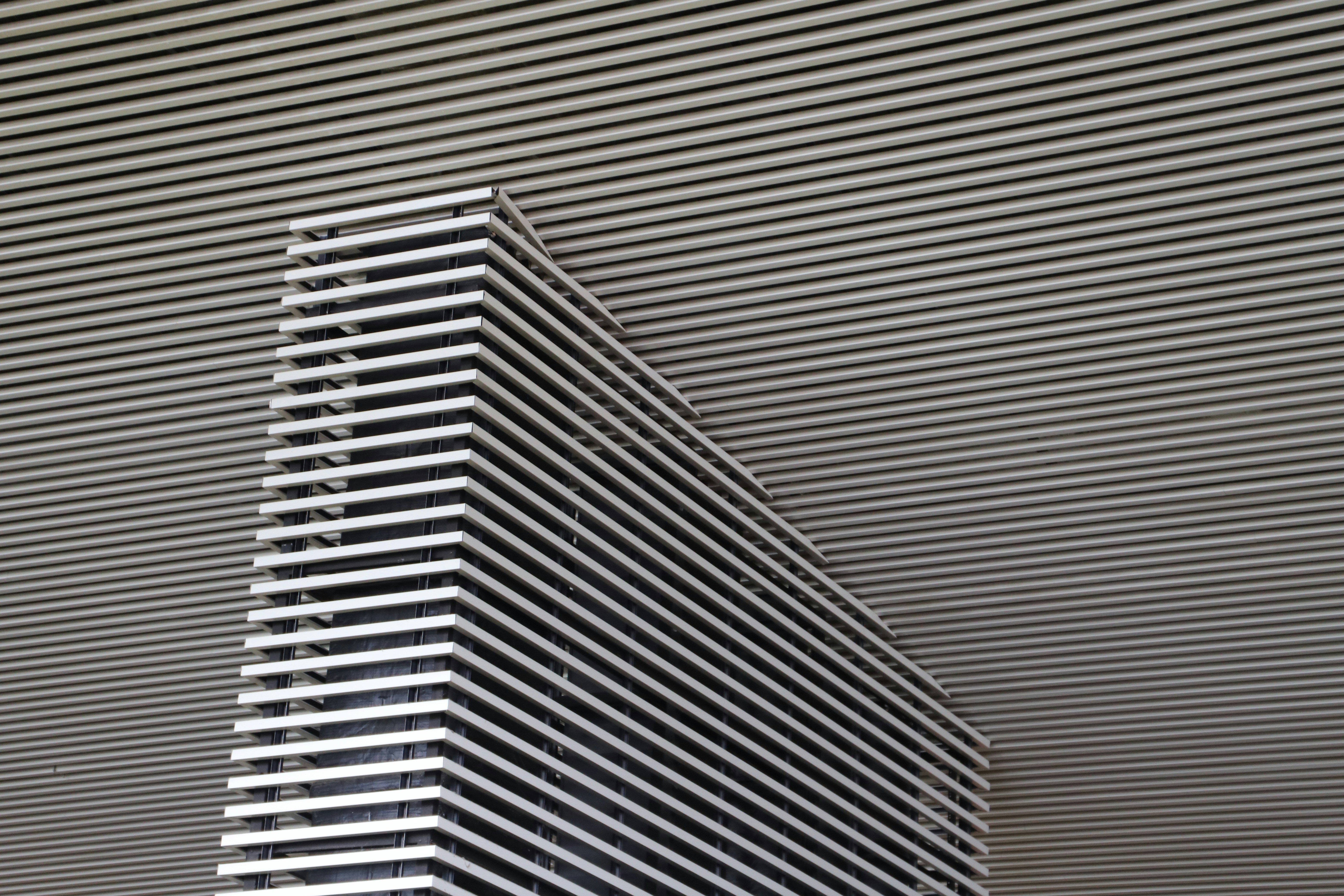 Striped architectural structure with parallel lines creating a dynamic visual pattern.