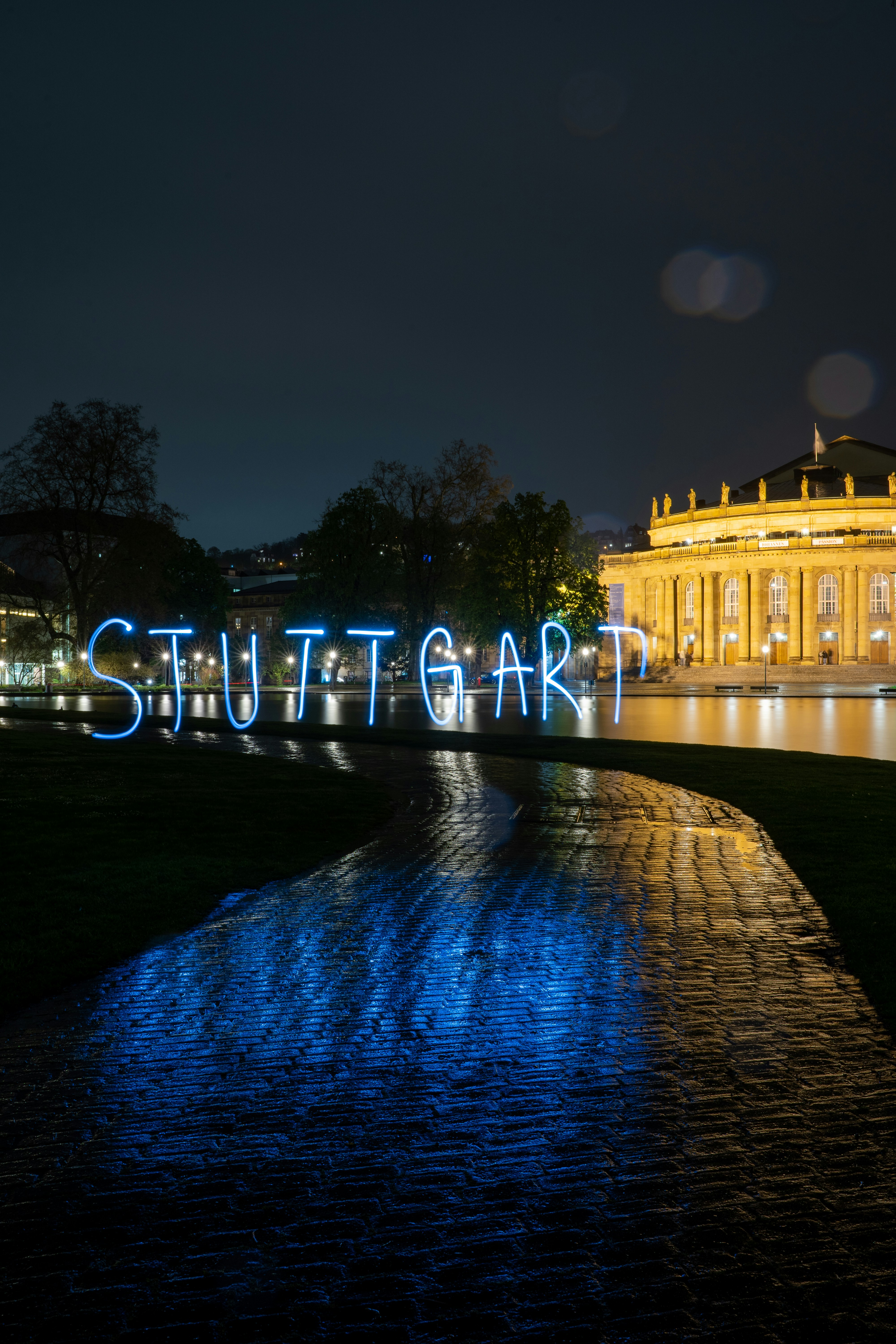 Stuttgart Night Light: Neon Letters Over the River