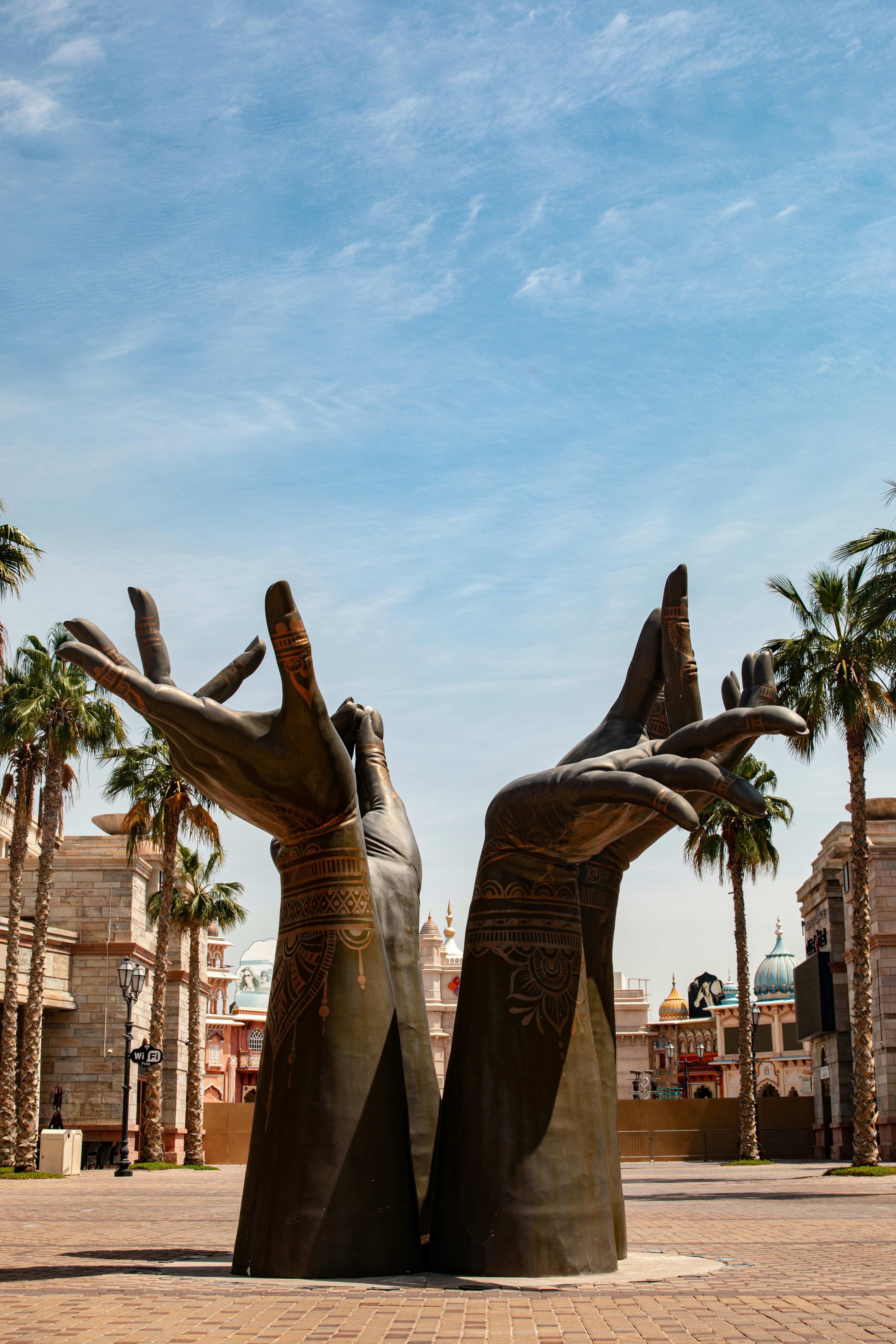 A statue of two hands holding each other photo – Free Dubai riverland ...