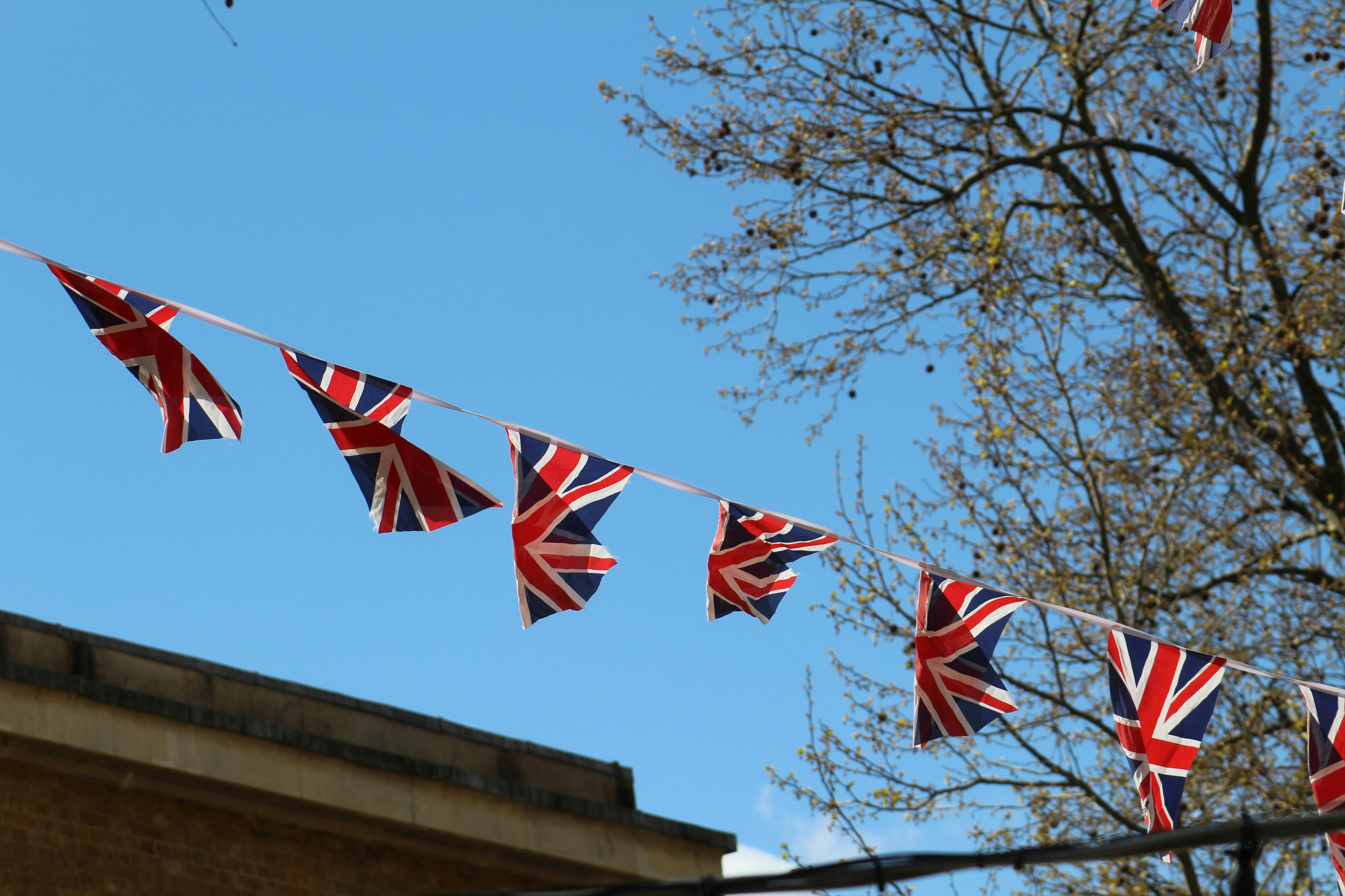 A bunch of british flags hanging from a line photo – Free Flags Image ...