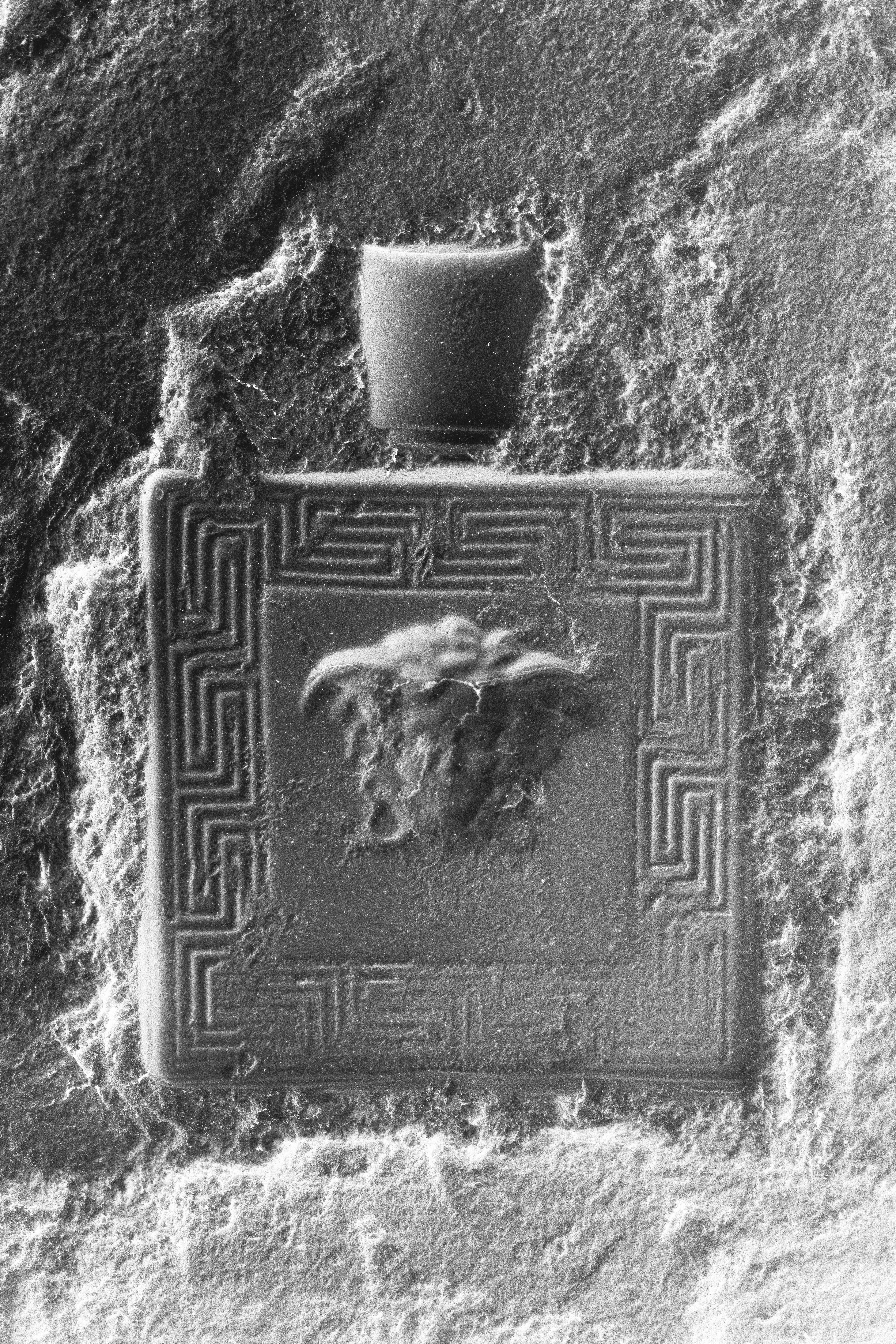 Ancient-Inspired Metal Pendant Adorned with Patterned Border and Central Emblem
