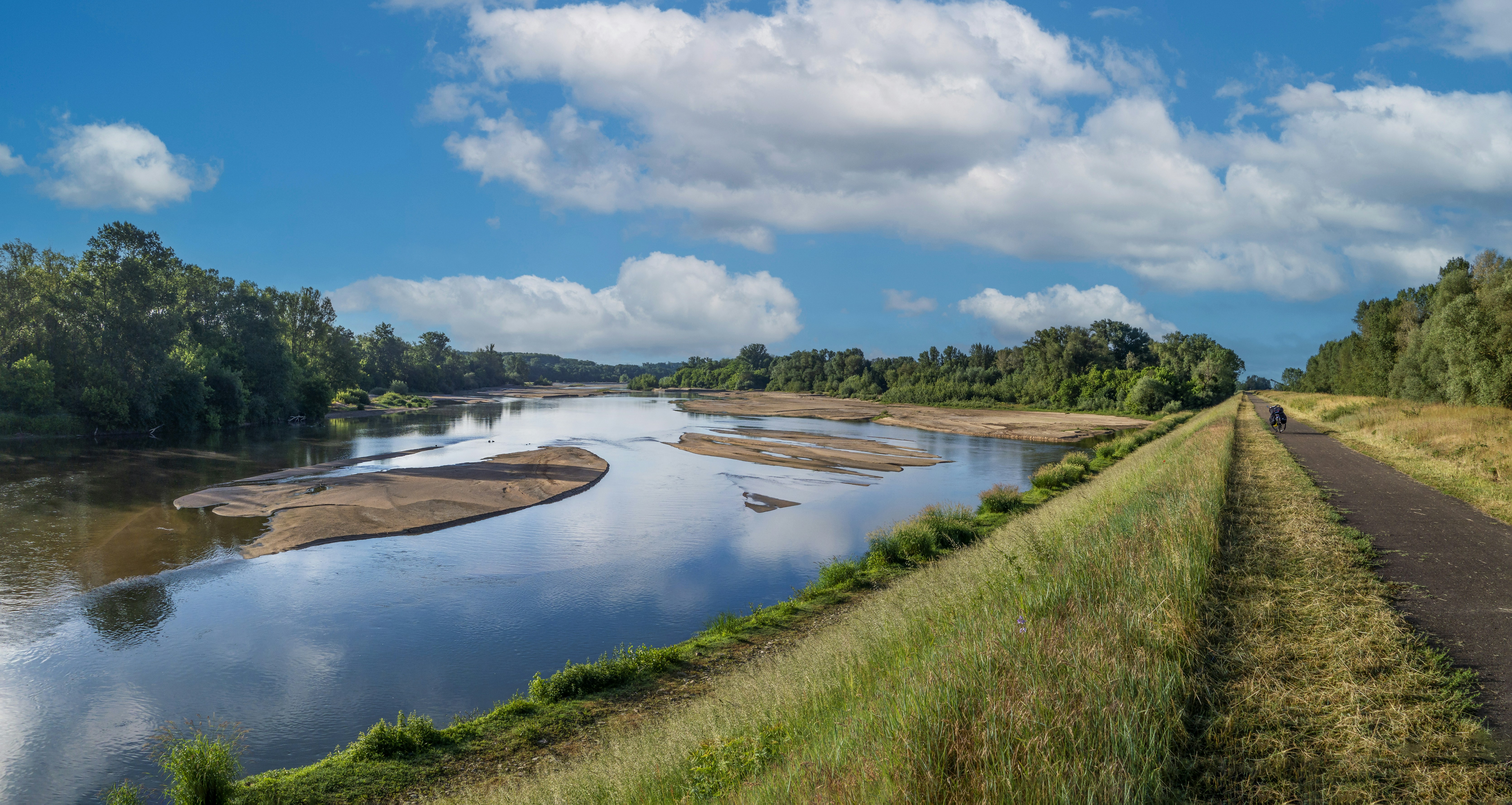 a river running through a lush green countryside