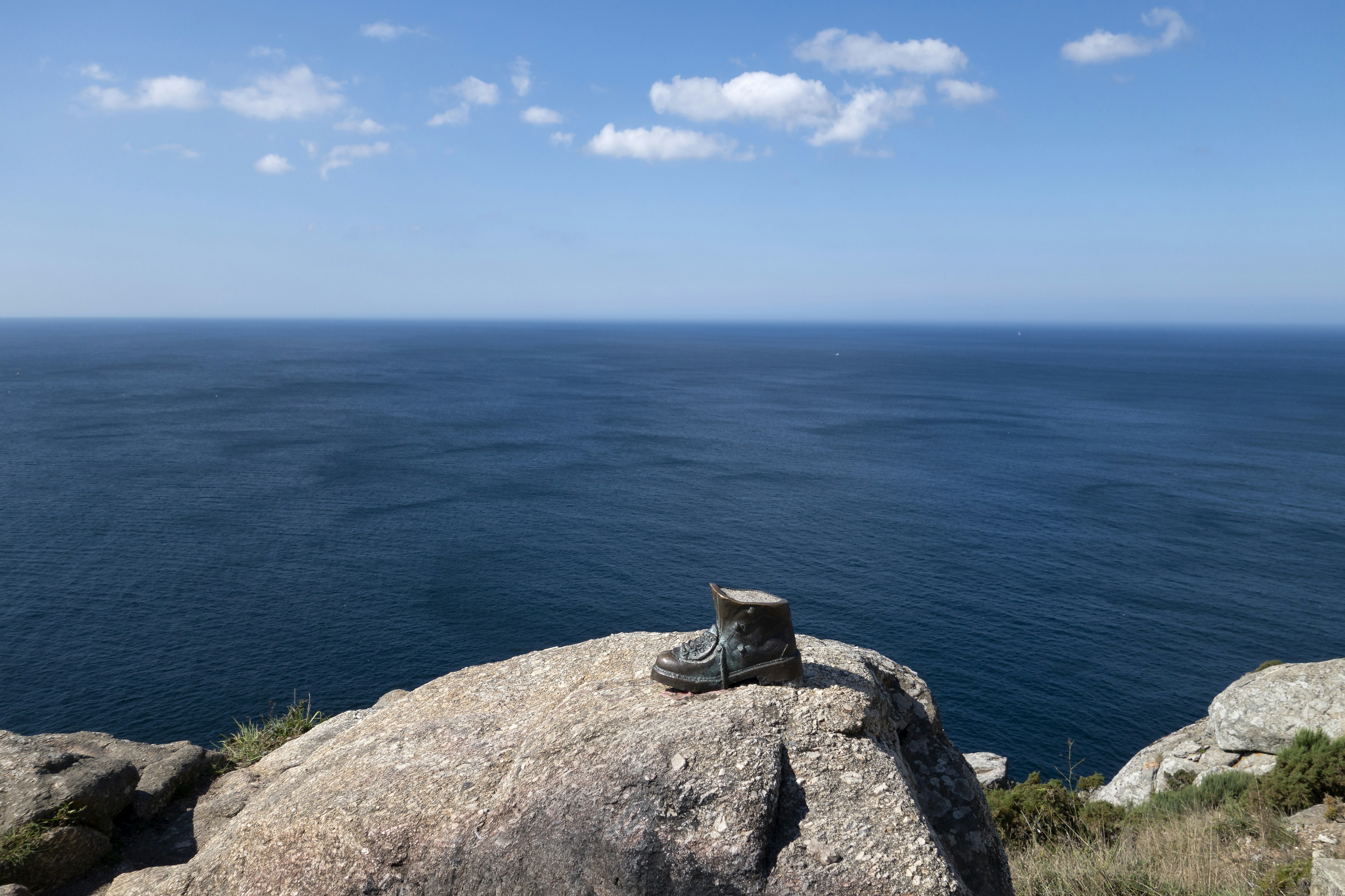 Boot at the Cliff: A Quiet Moment Over the Open Sea