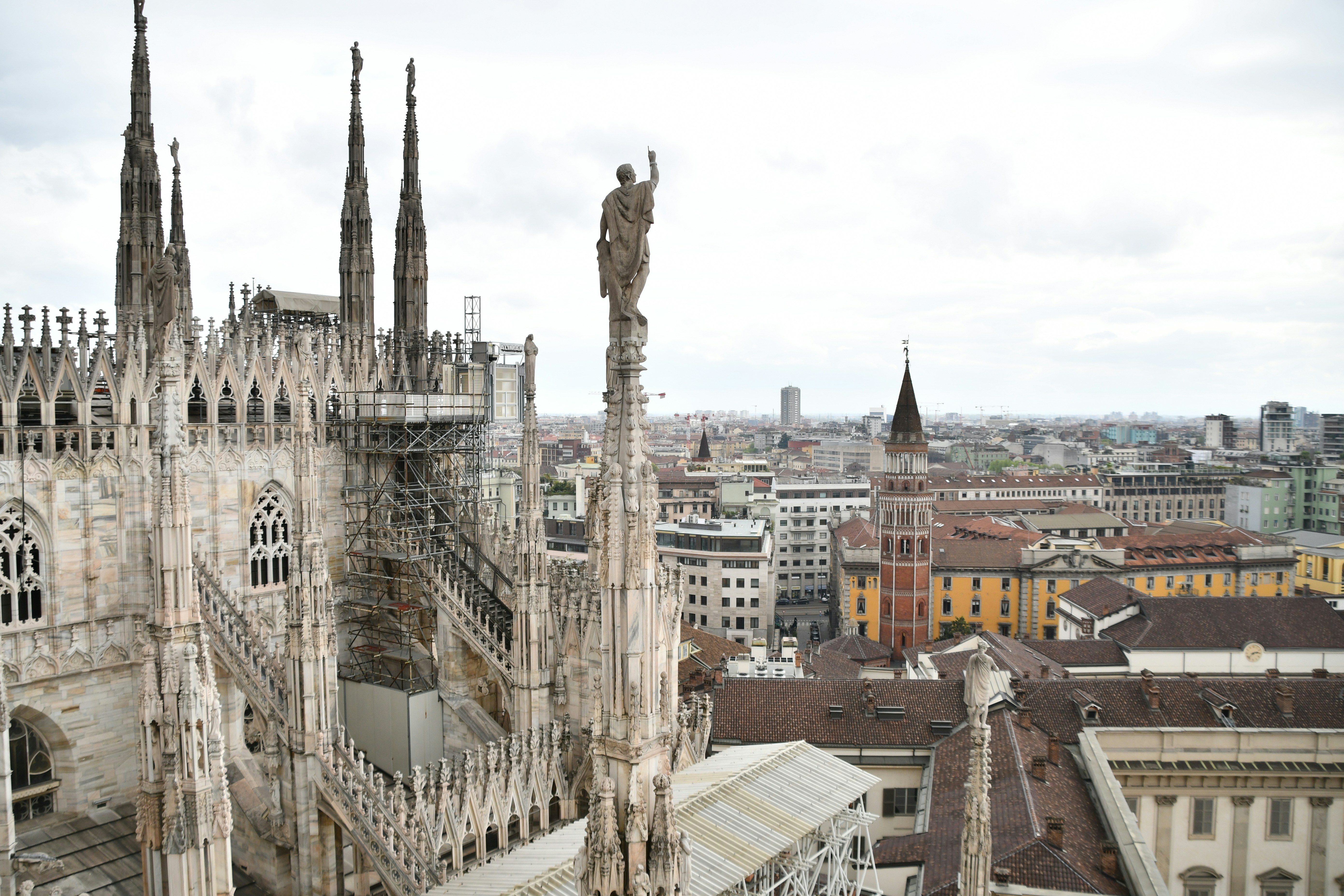 Flying buttresses and cityscape: a rooftop glimpse of Gothic spires amid an urban horizon