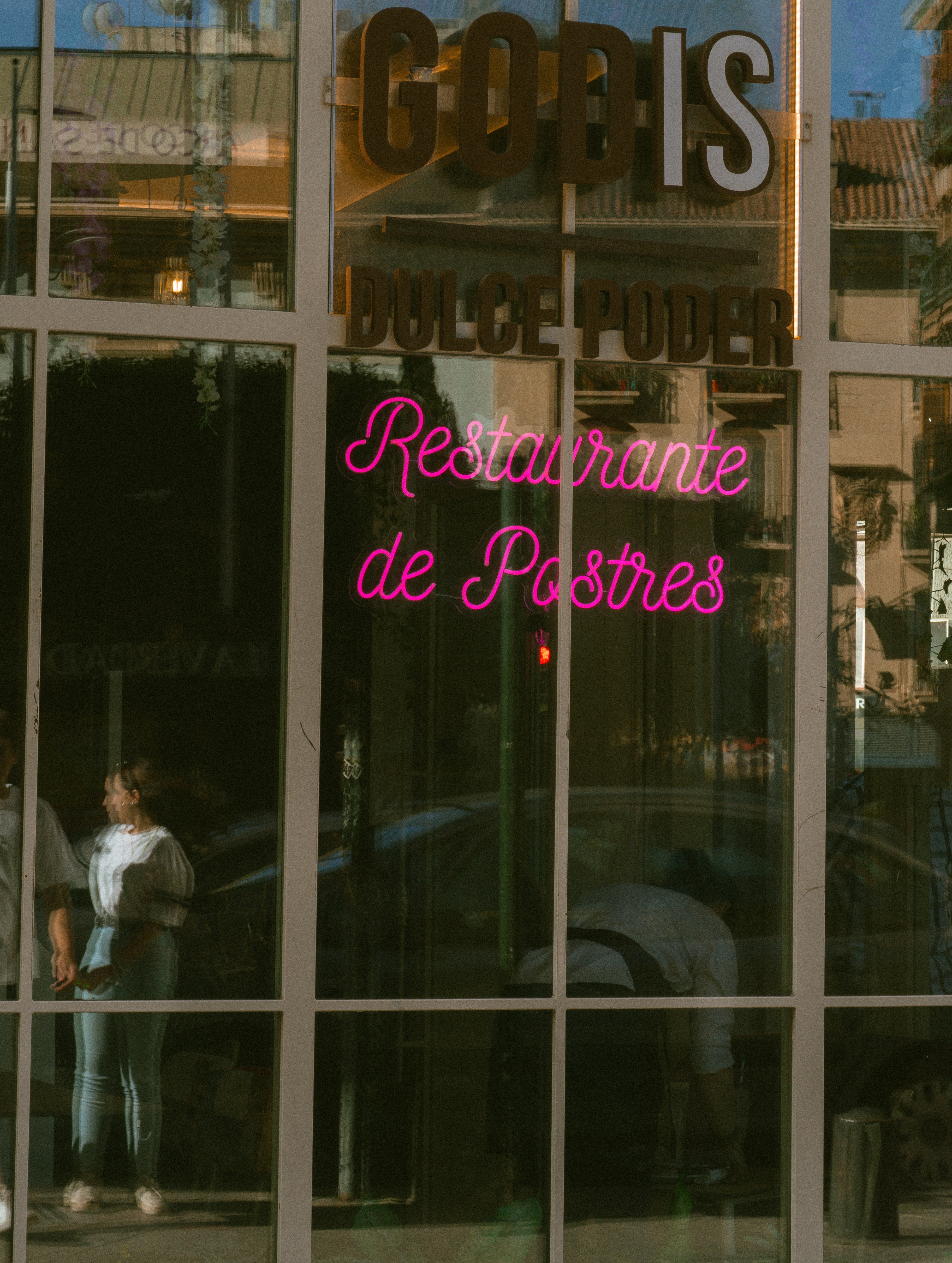 a store front with a woman standing in the window