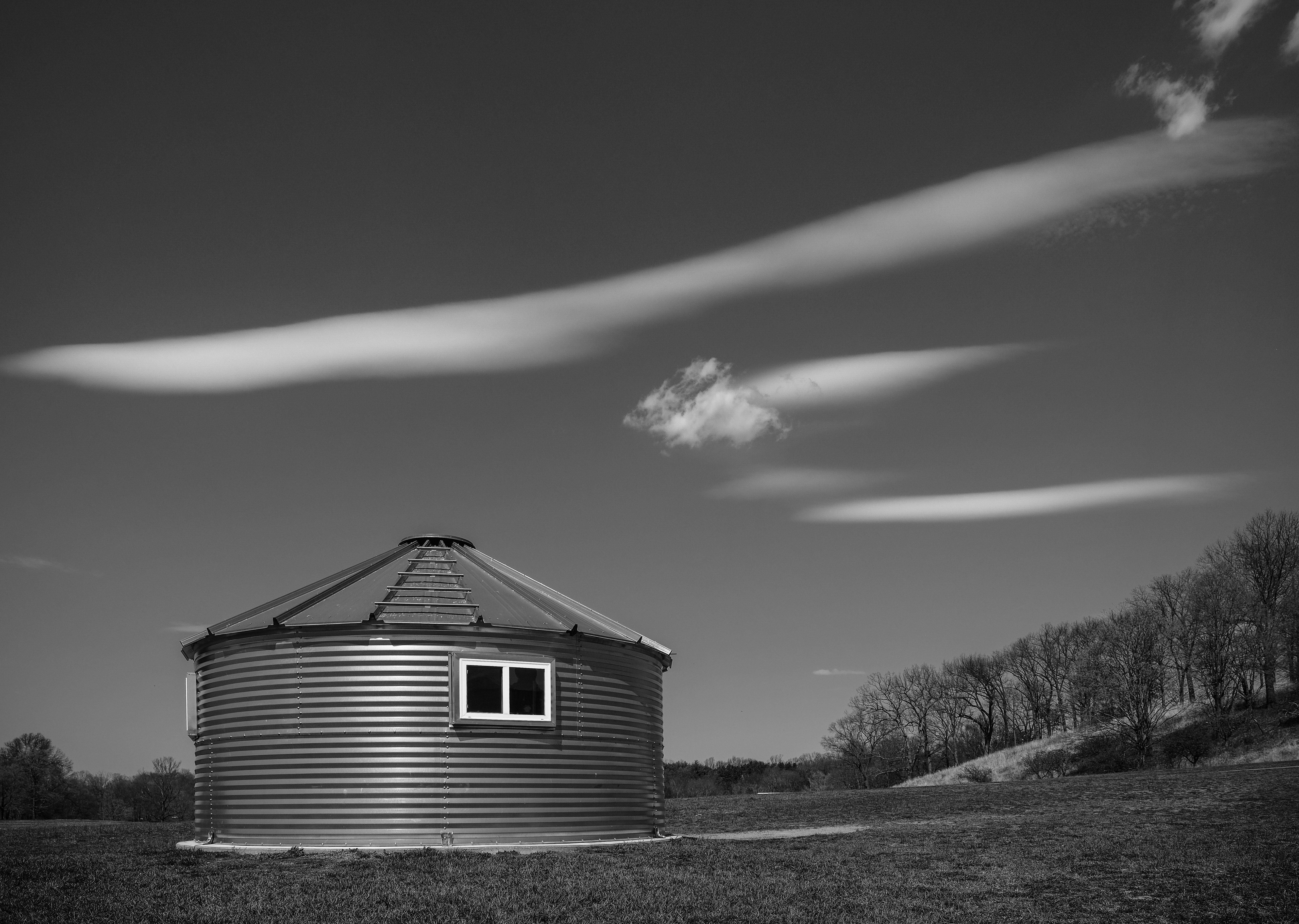 Ribbed Silhouette: A Lone Silo Anchored by Quiet Prairie