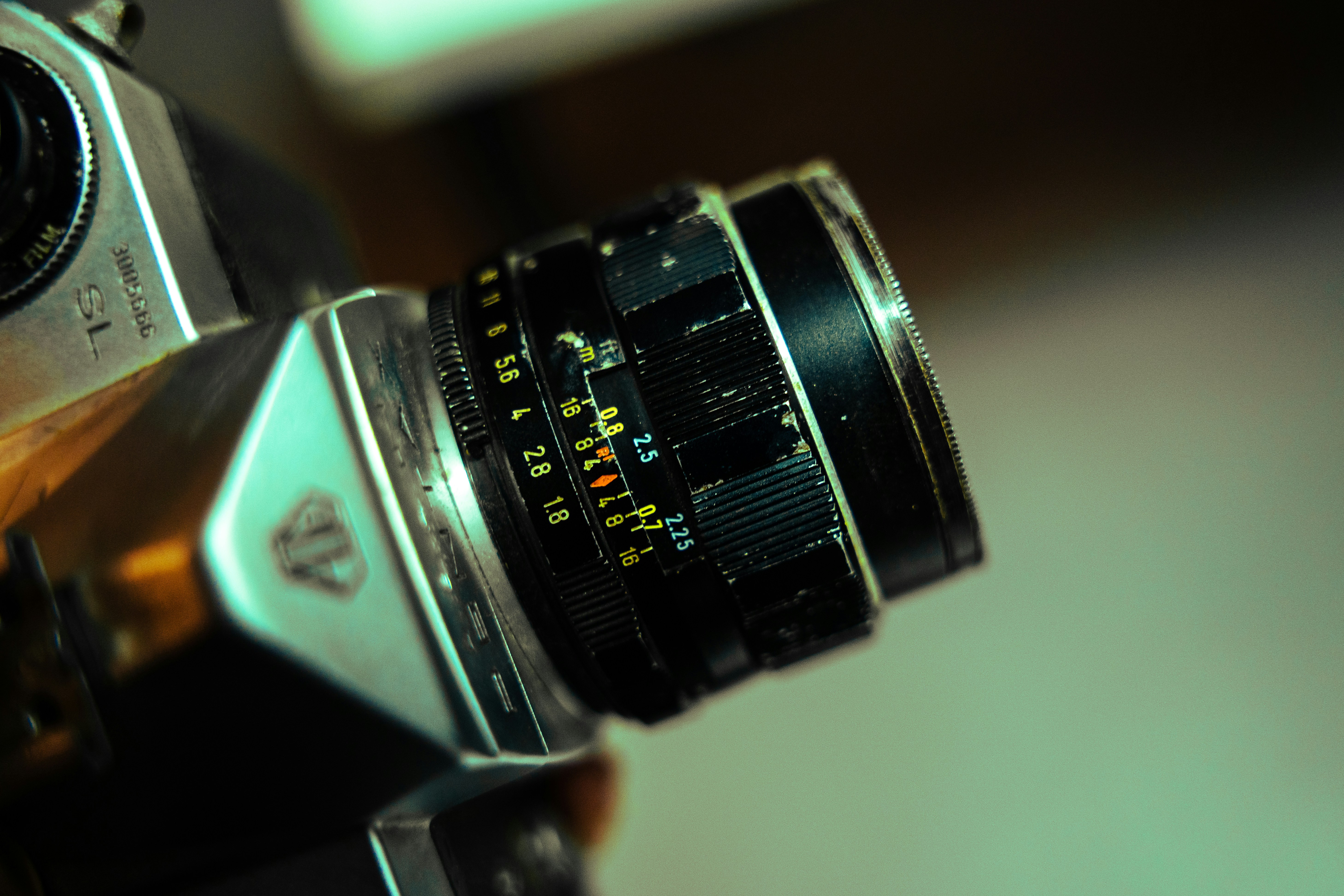 Close-up of a vintage camera lens showcasing intricate mechanical details and markings.