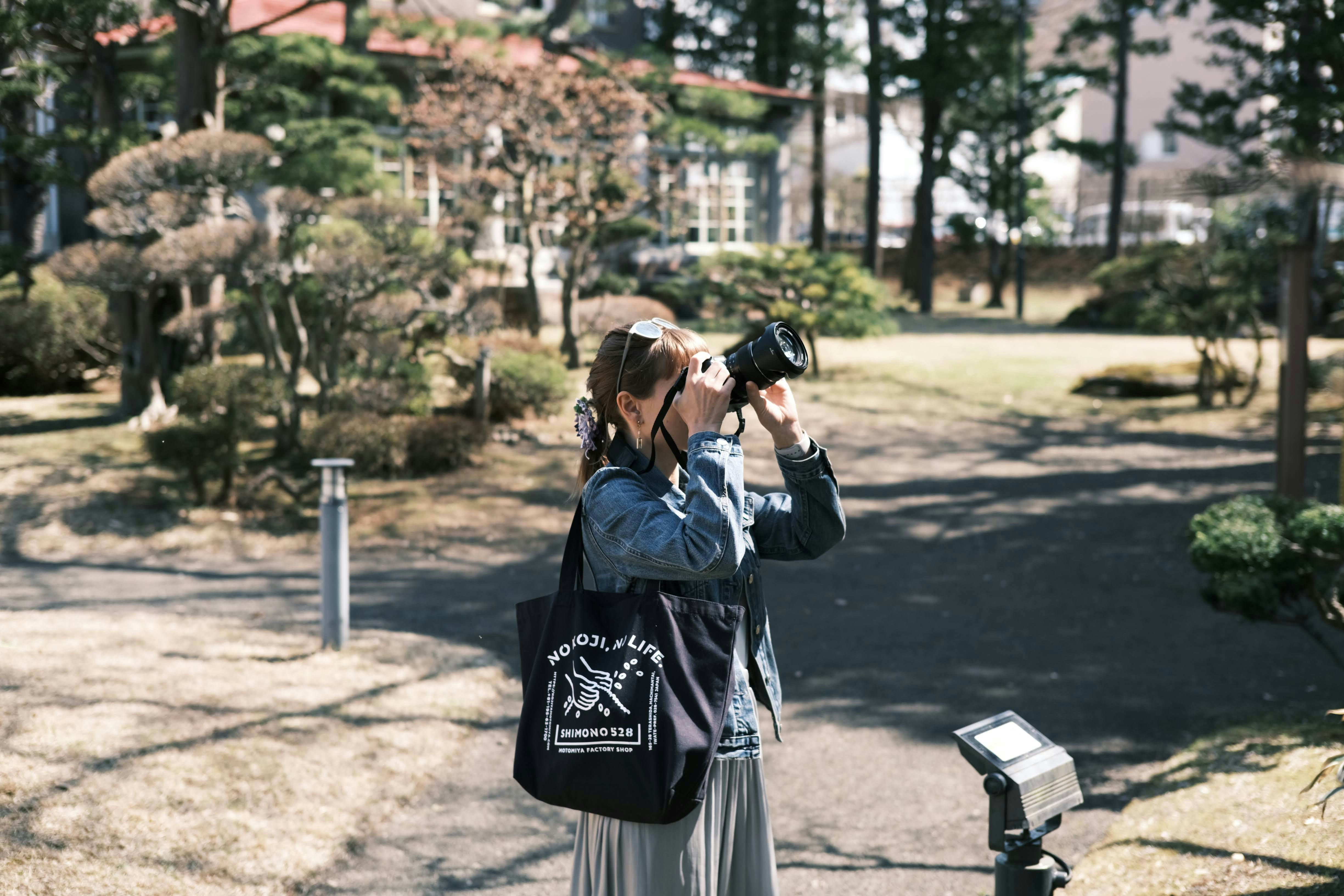 Sunlit Park Portrait: A Photographer Framing Light