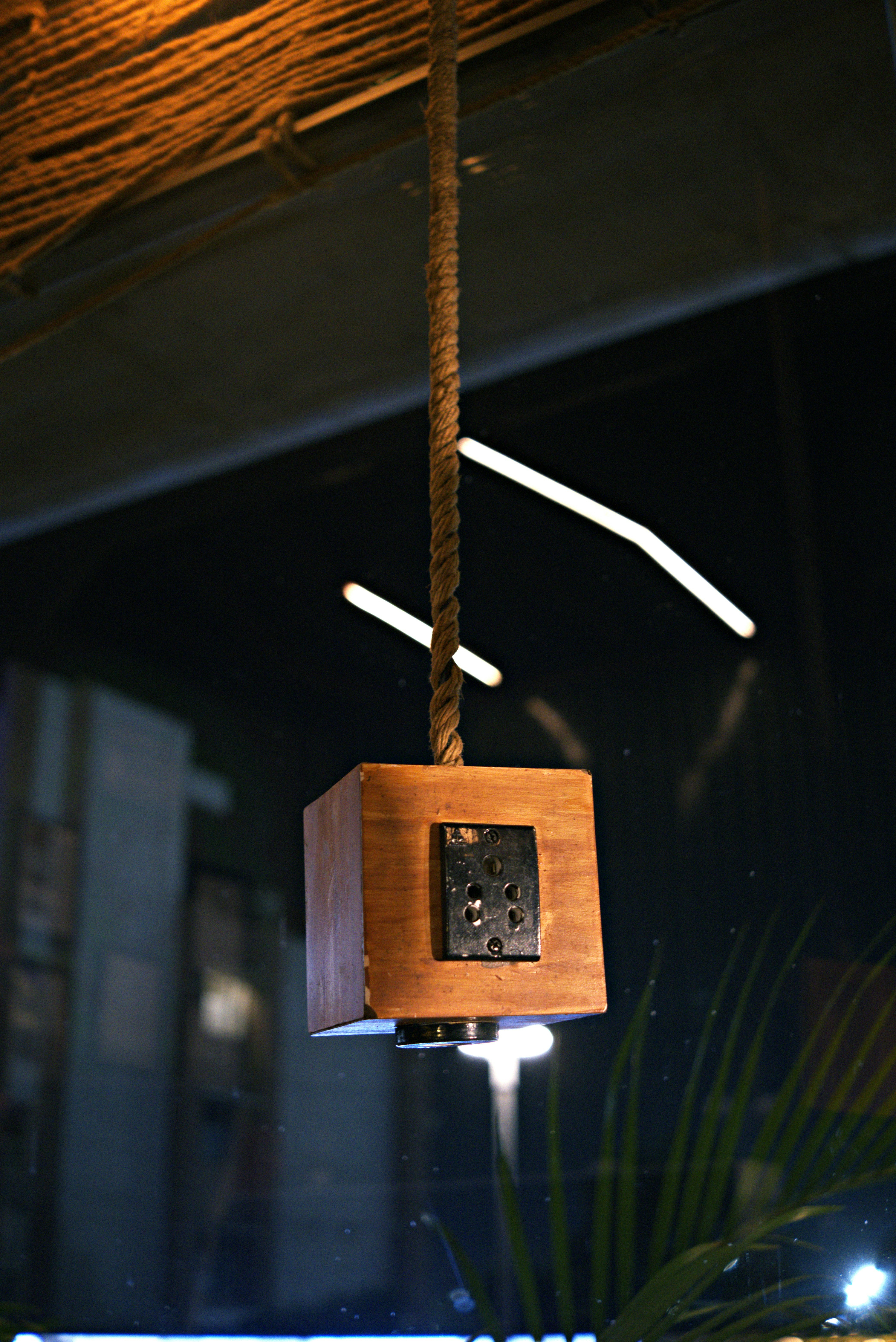 A wooden object hanging from a rope in a room photo – Free Wood Image ...