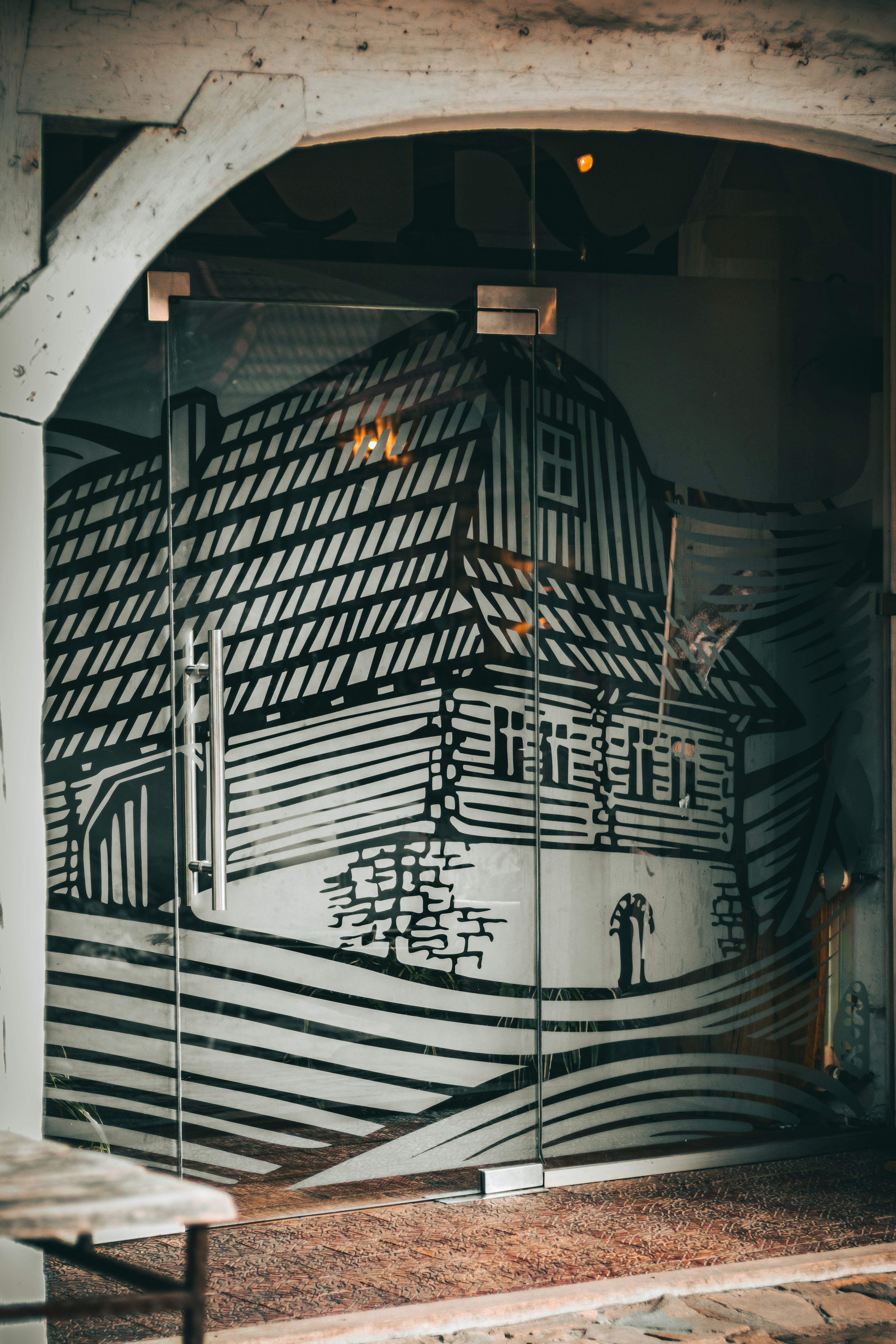 Striped House on Glass Doors: A Storefront Mural that Divides Light and Pattern