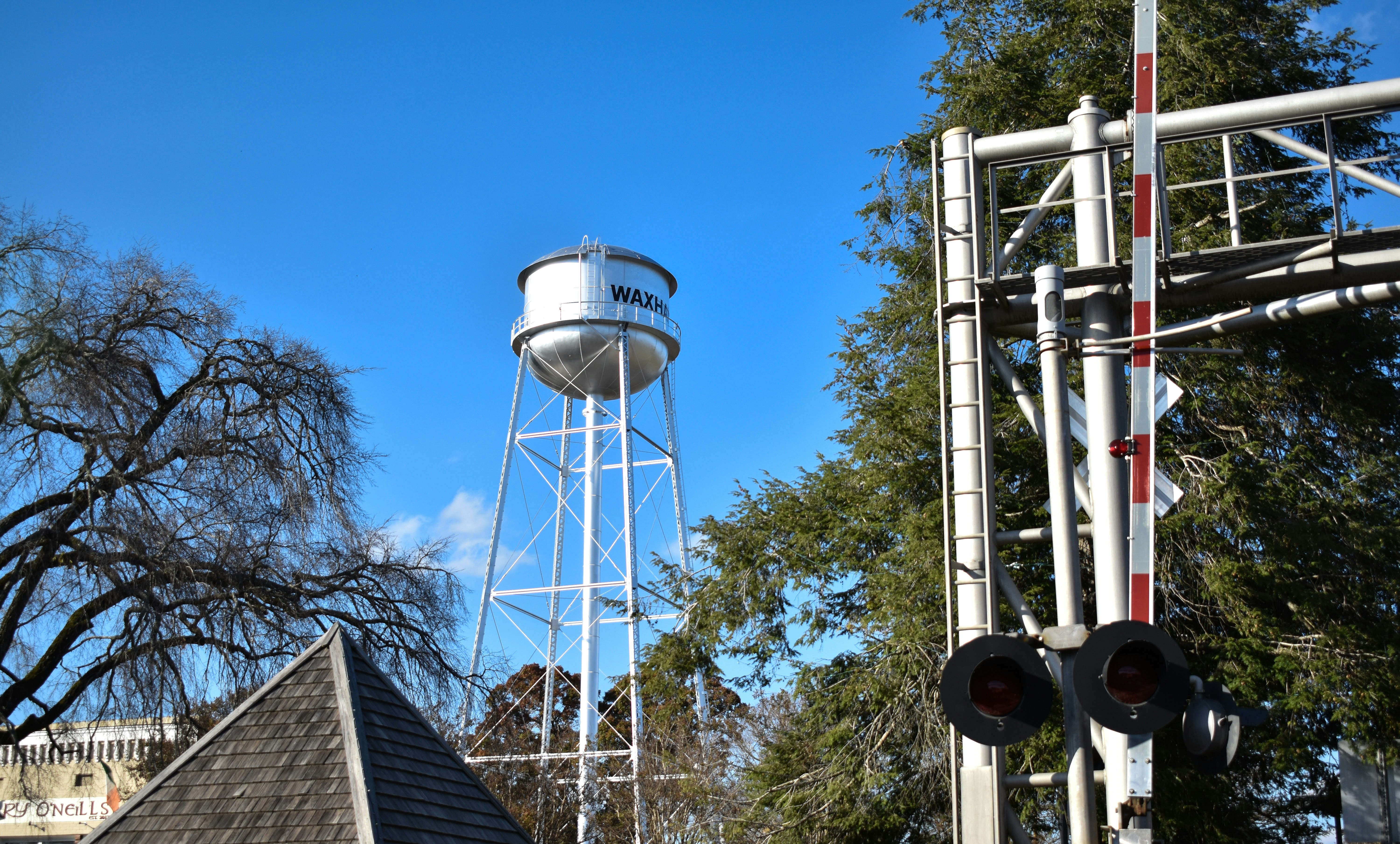 A tall white water tower next to a traffic light photo – Free Waxhaw ...