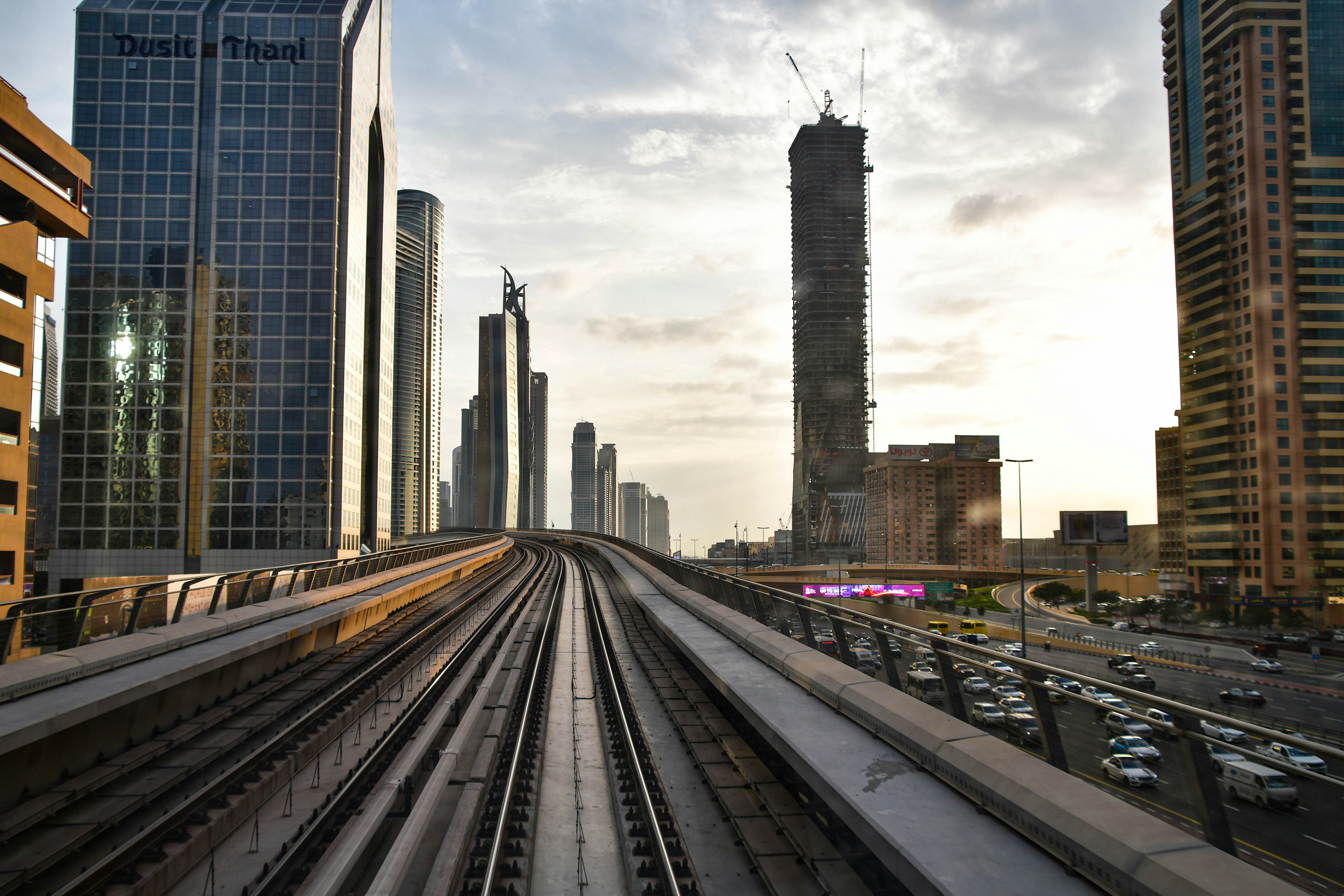 A train track running through a city with tall buildings photo – Free ...