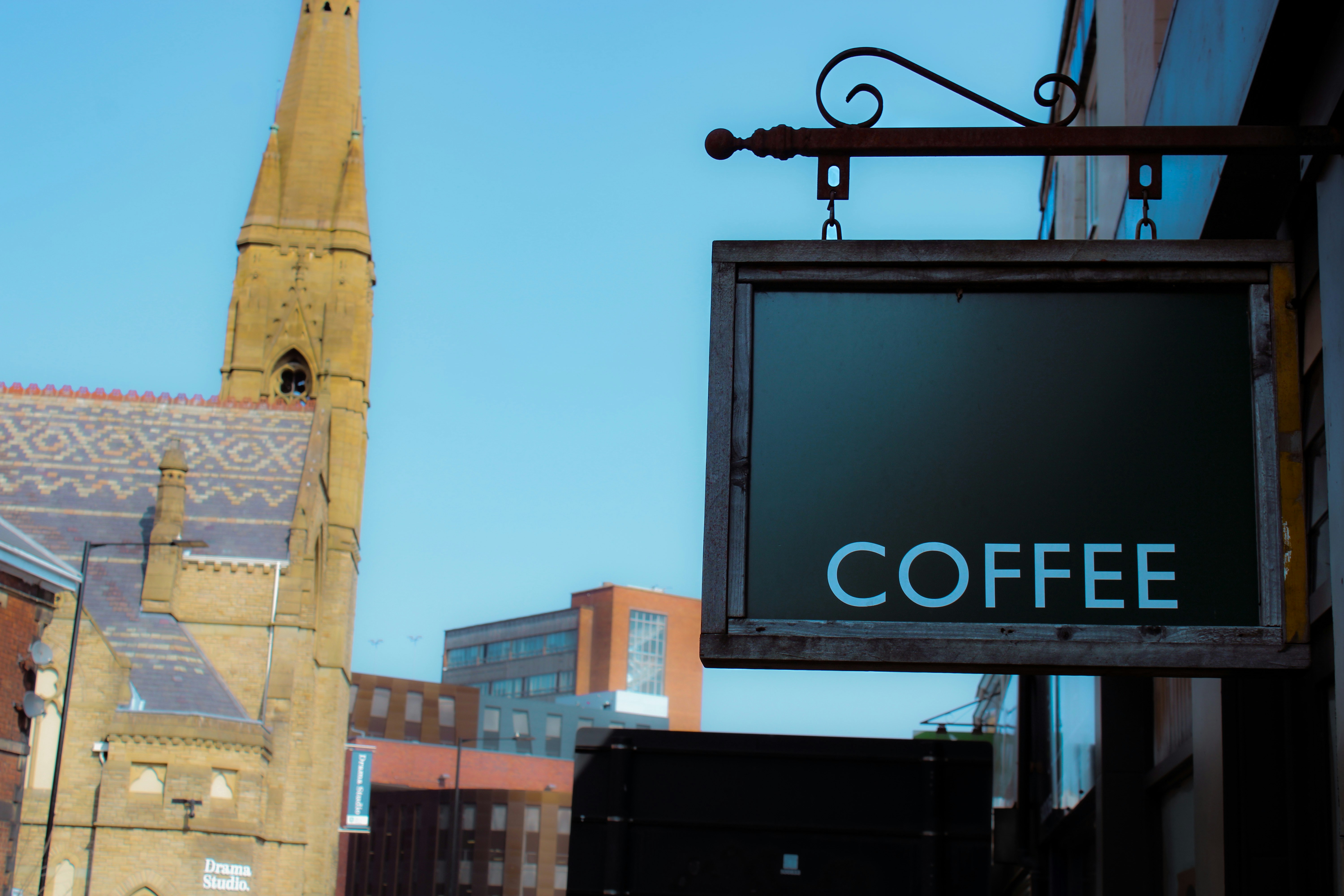 Cafe Sign in a City Scene with Historic Architecture