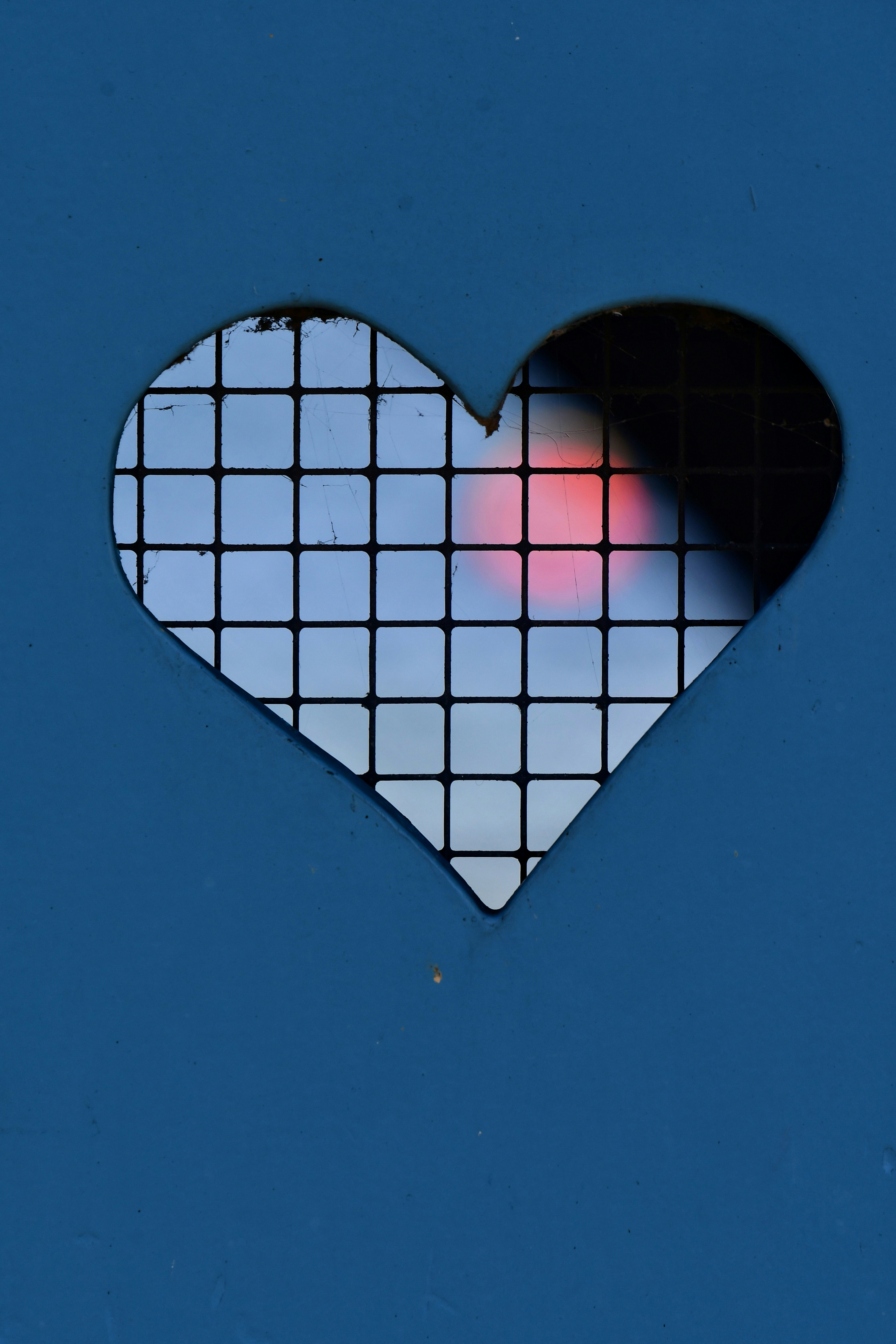 Heart through the Mesh: Blue Panel with Grid-Cutout Window