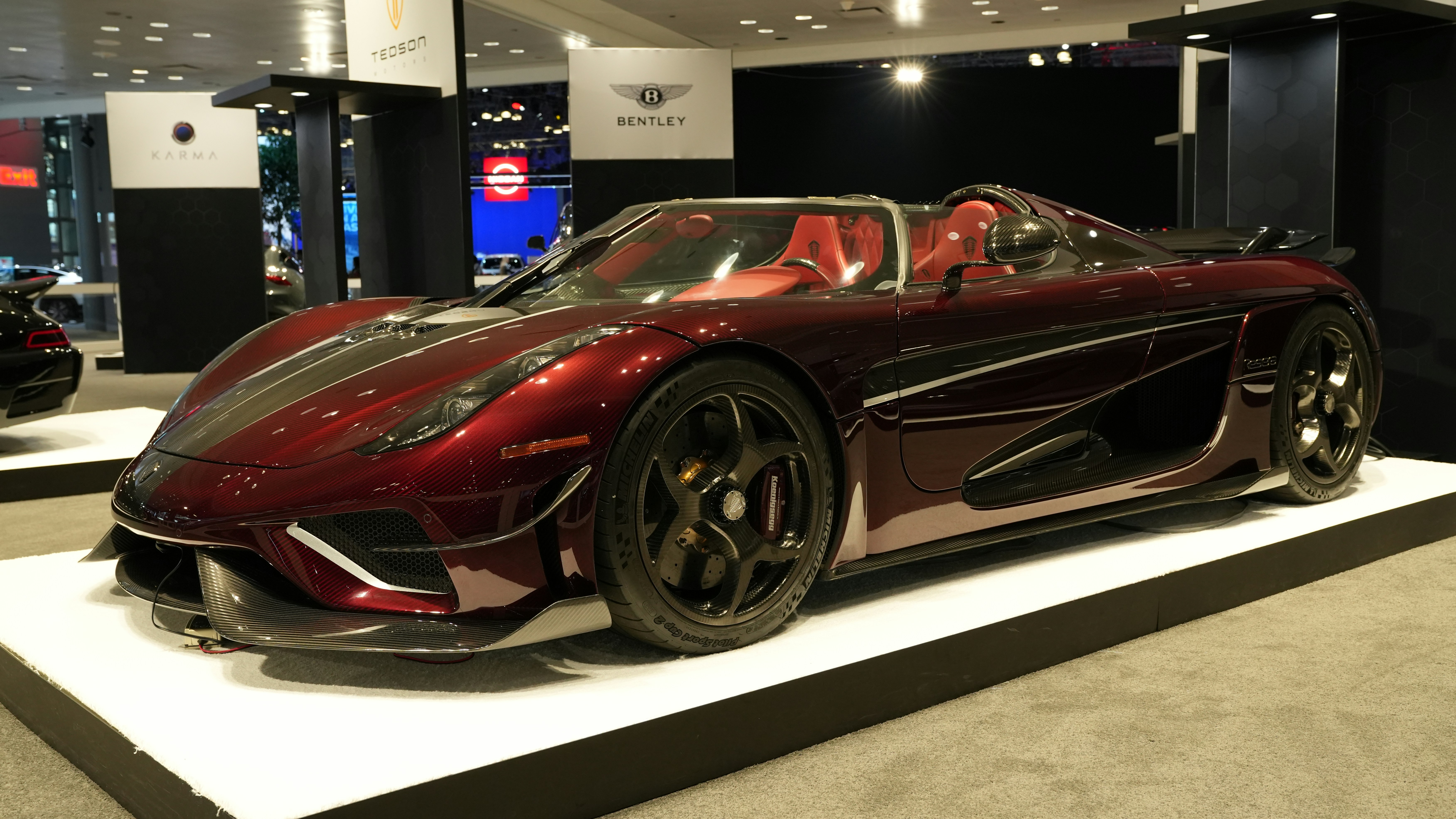 A red sports car on display in a showroom photo – Free Hypercar Image ...