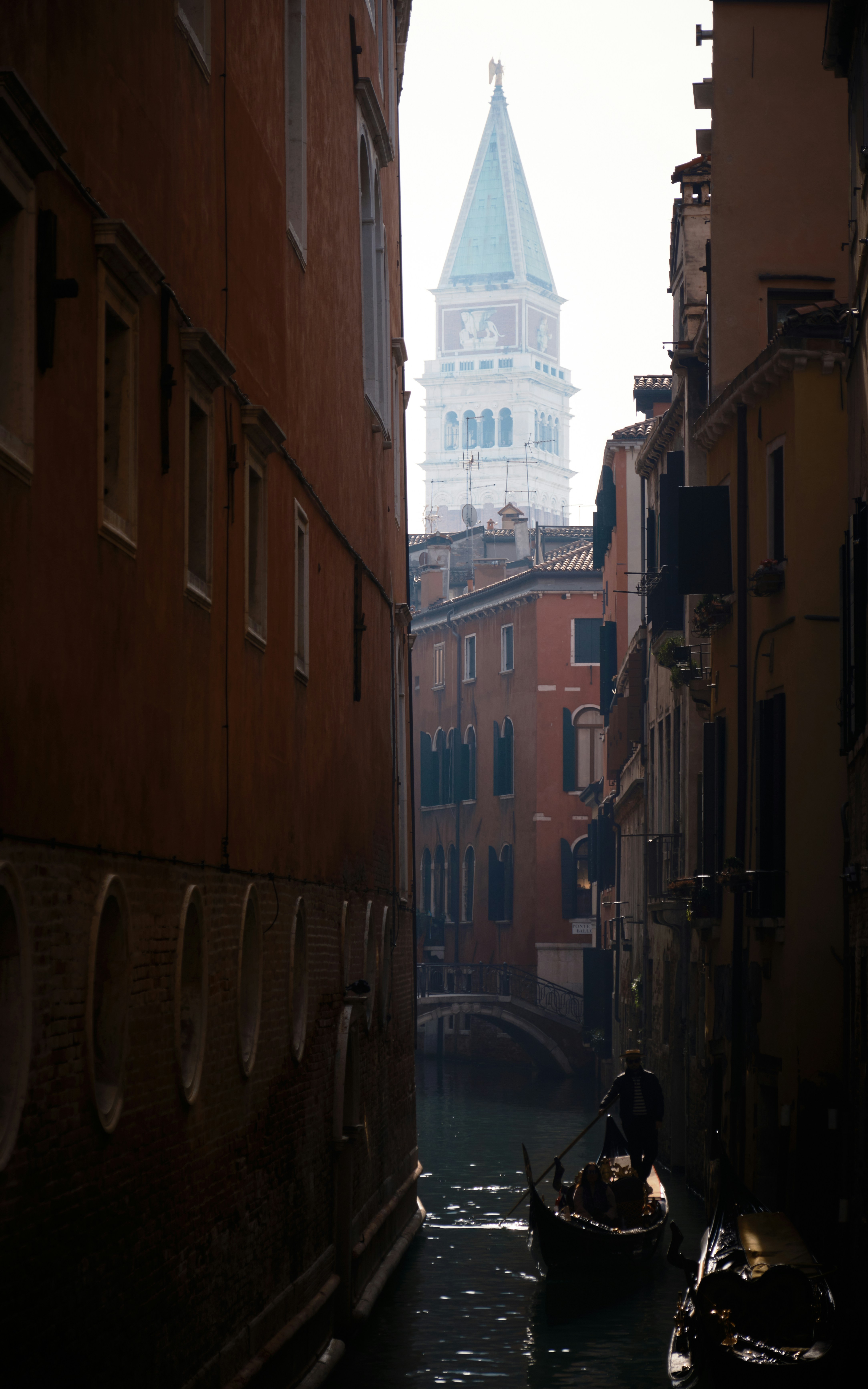 Vanishing Canal: Bell Tower Reaching Through the Narrow Venetian Gorge