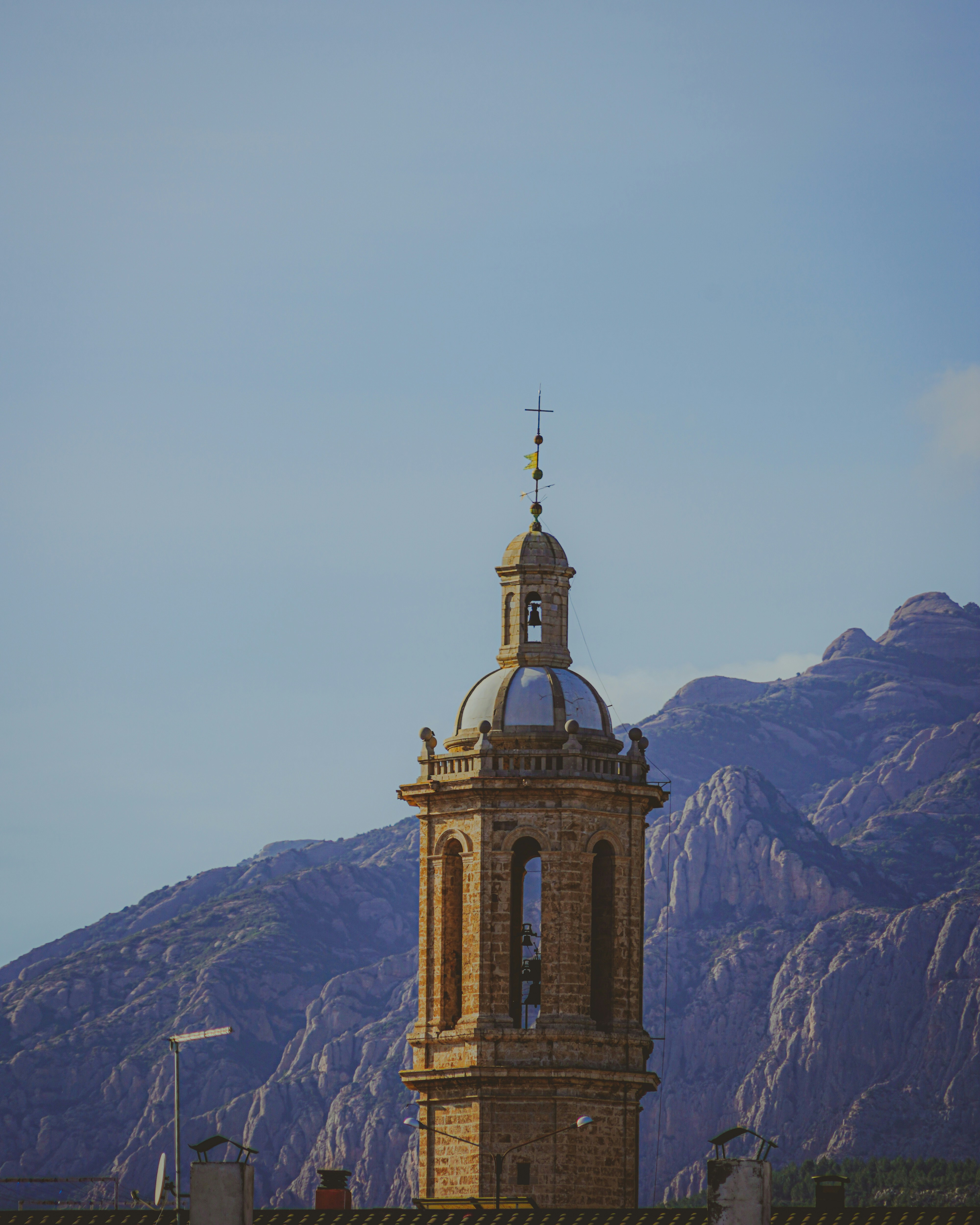 A clock tower with a mountain in the background photo – Free Church ...